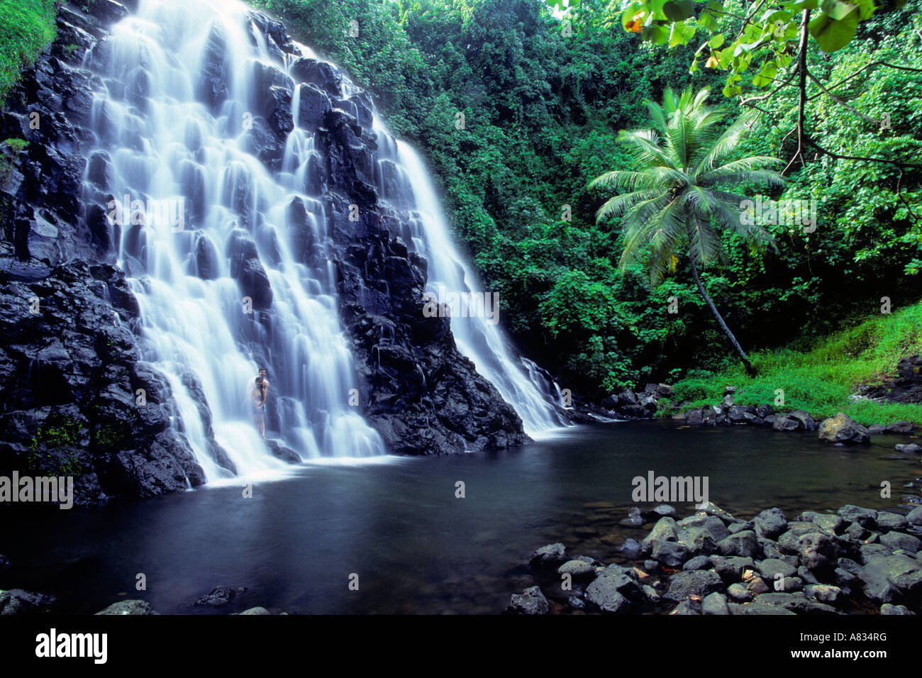 A couple cooling of in the Kepirohi Waterfall, Pohnpei, Micronesia ...