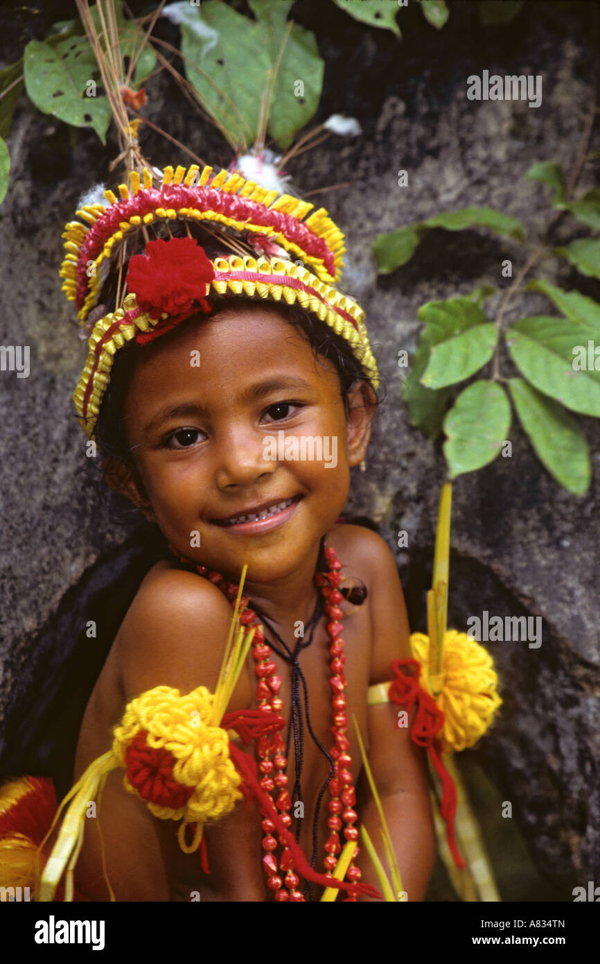 This young girl in a traditional outfit pictured in front of stone ...