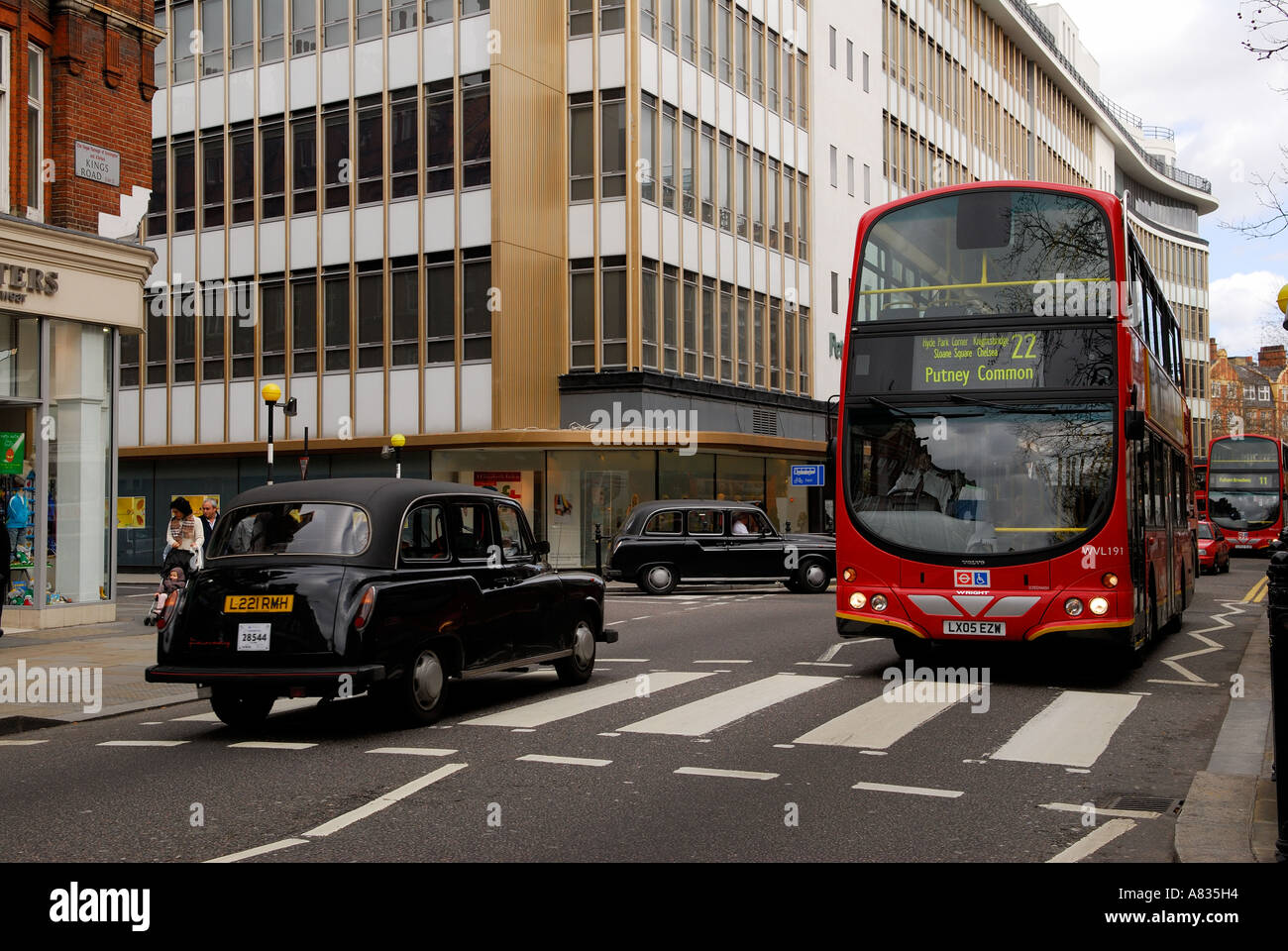 London taxi and red buses outside the department store Peter Jones ...
