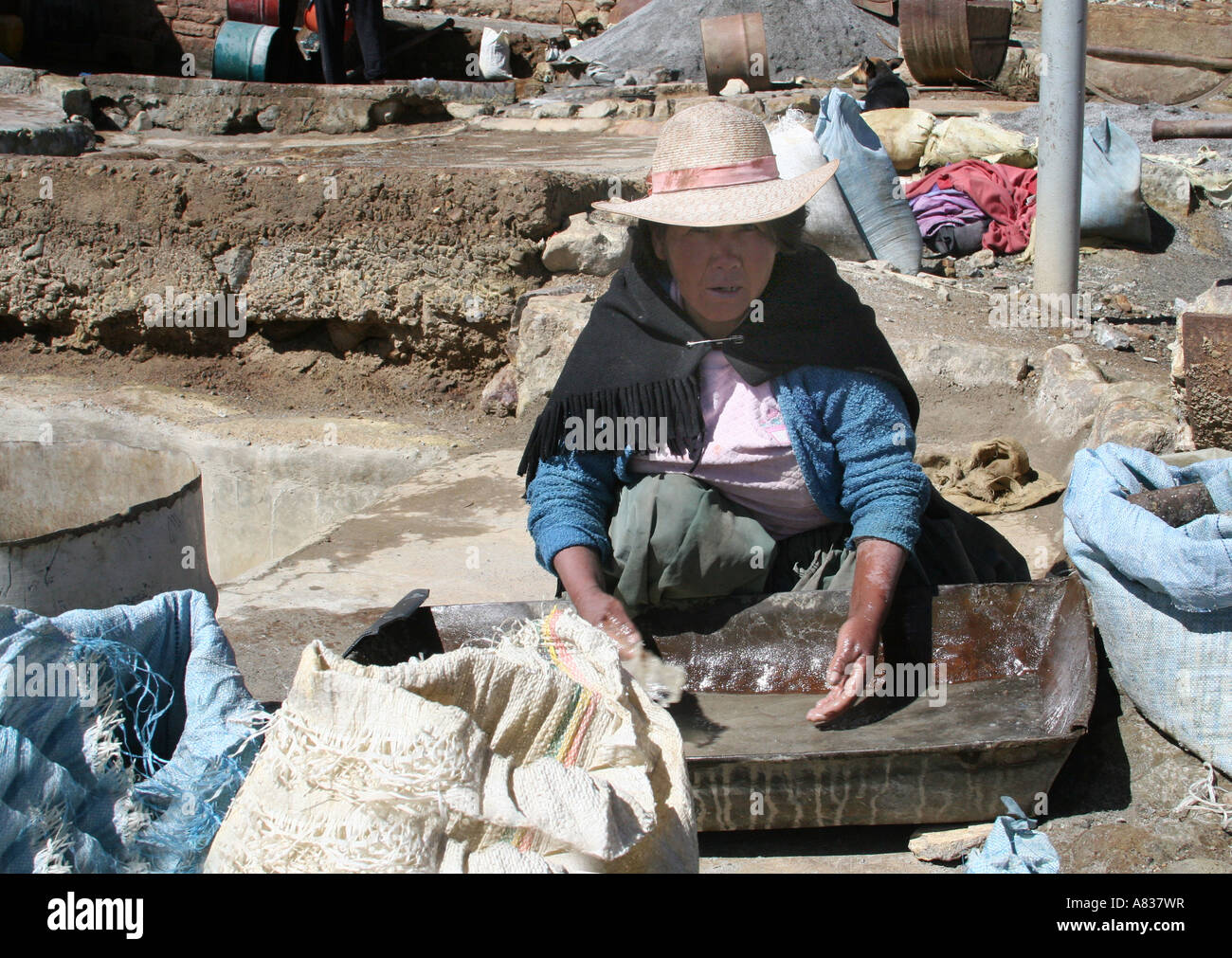 Woman in hat washing tin ore Stock Photo - Alamy
