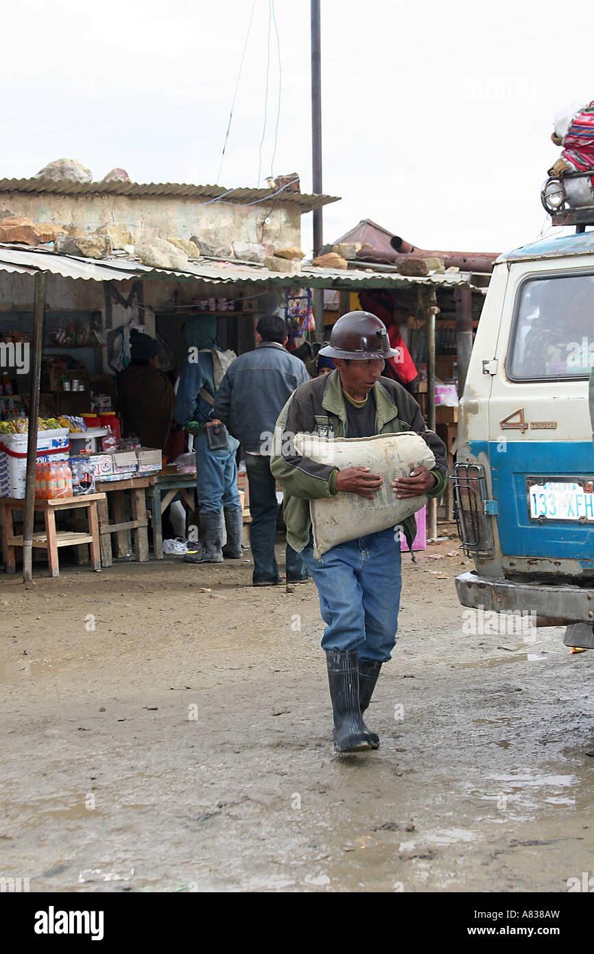 Miner carrying a bag of tin ore Stock Photo - Alamy