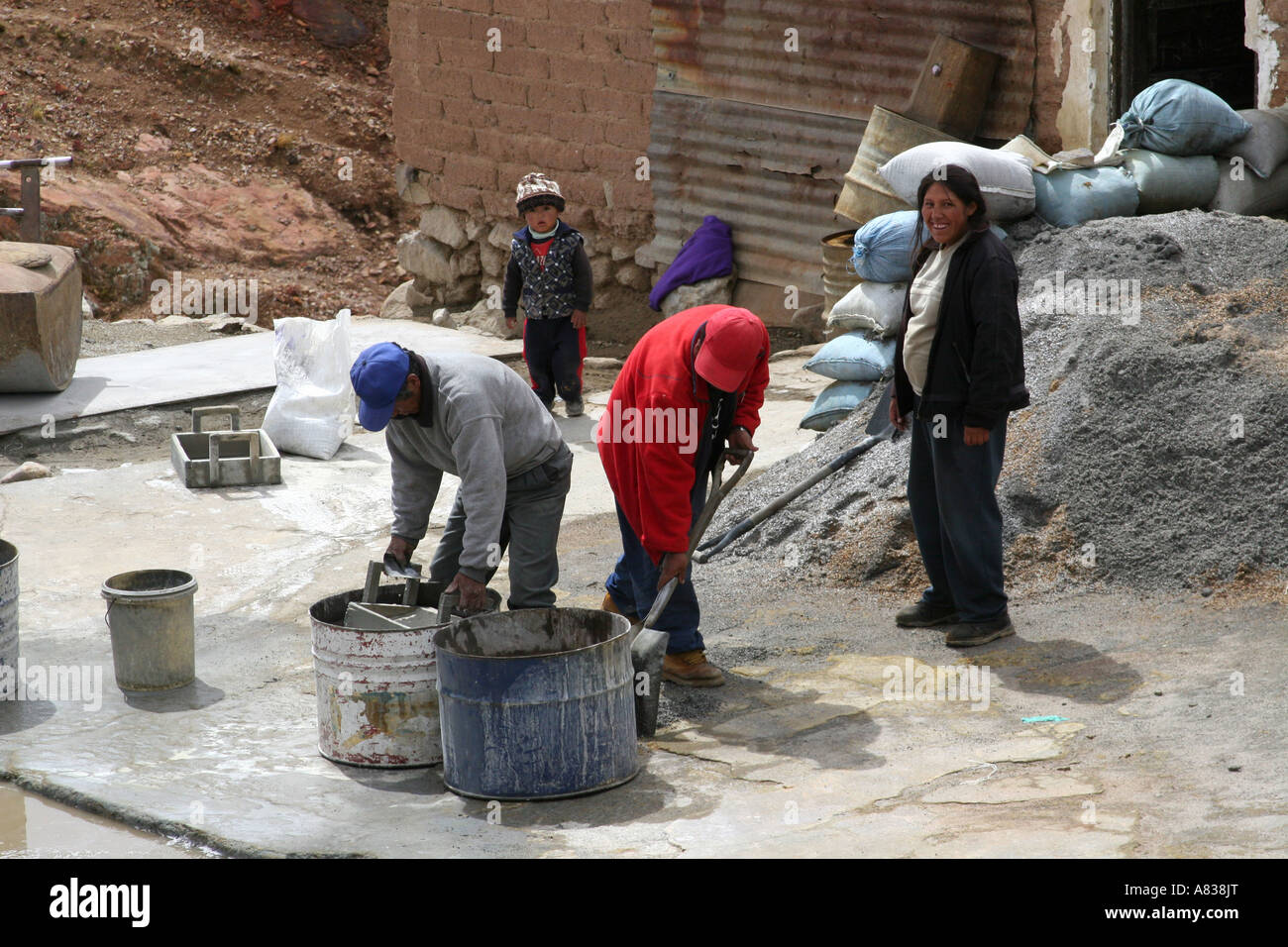 A family of miners crushing tin ore in Siglo XX, Llallagua, Potosi ...