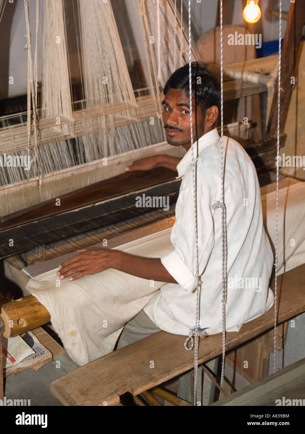 Varanasi Benares Uttar Pradesh India Man sat working at loom weaving ...