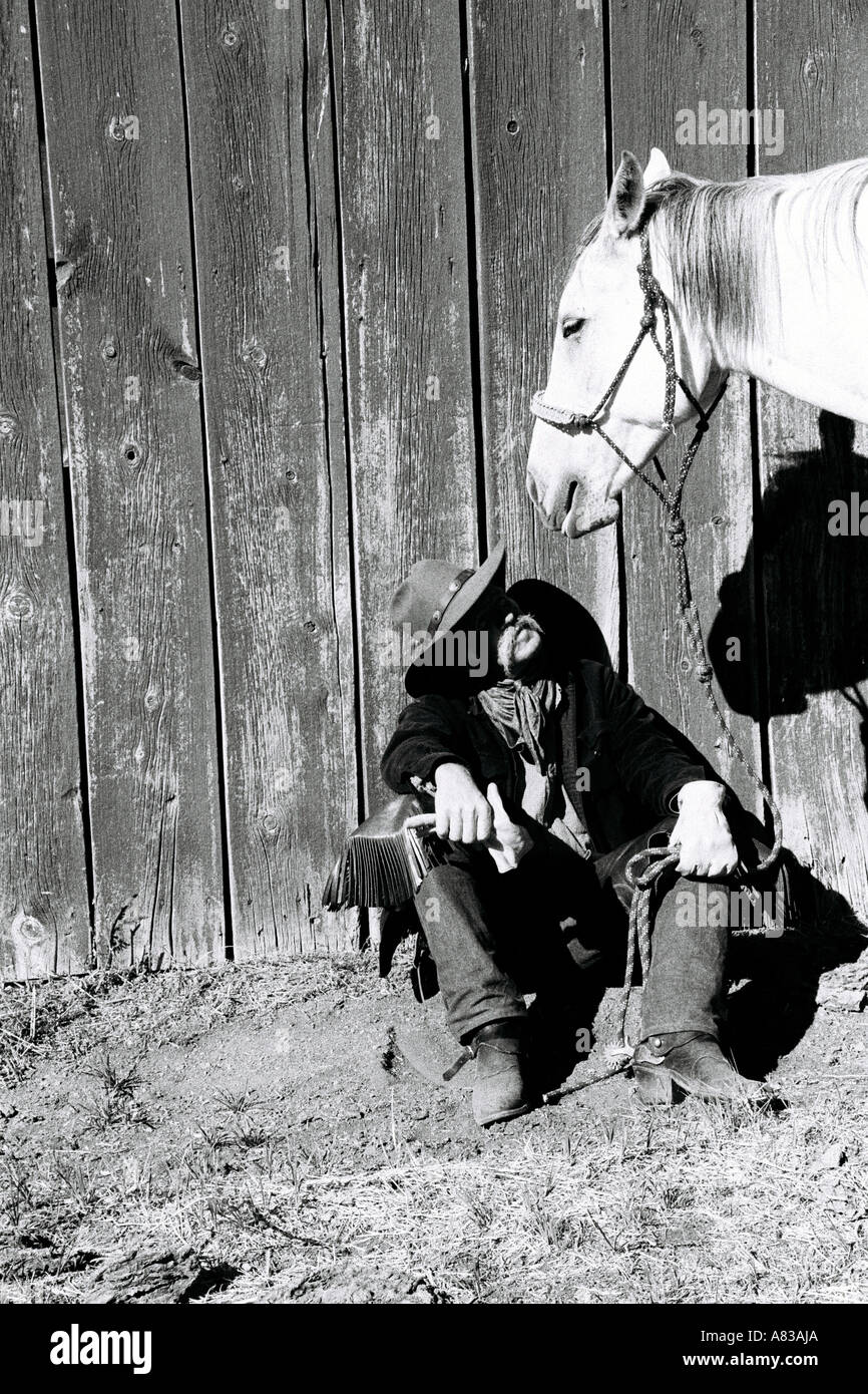 A cowboy looking up at his horse in Oregon Stock Photo - Alamy