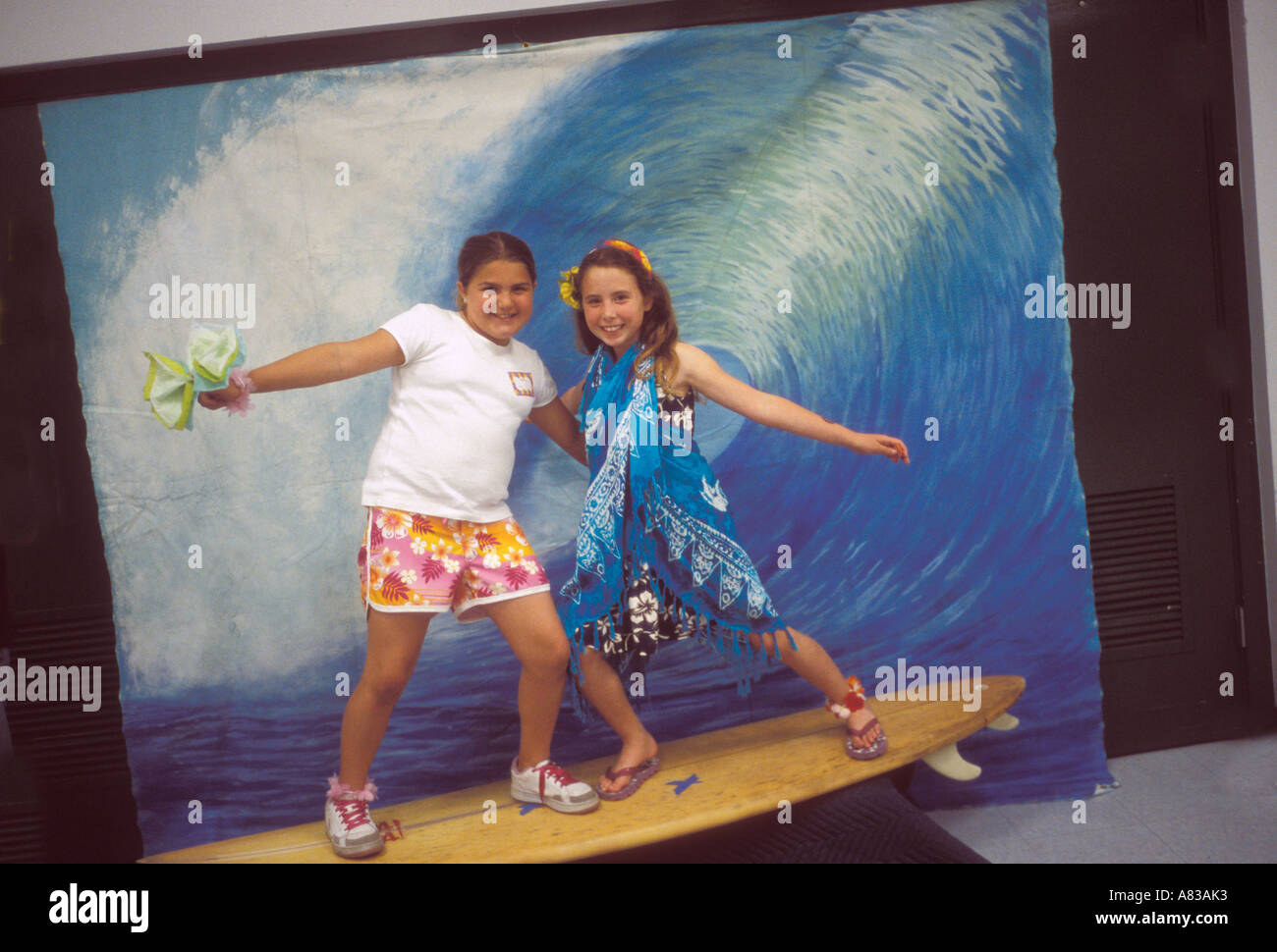 Kids posing on a surfboard Stock Photo - Alamy