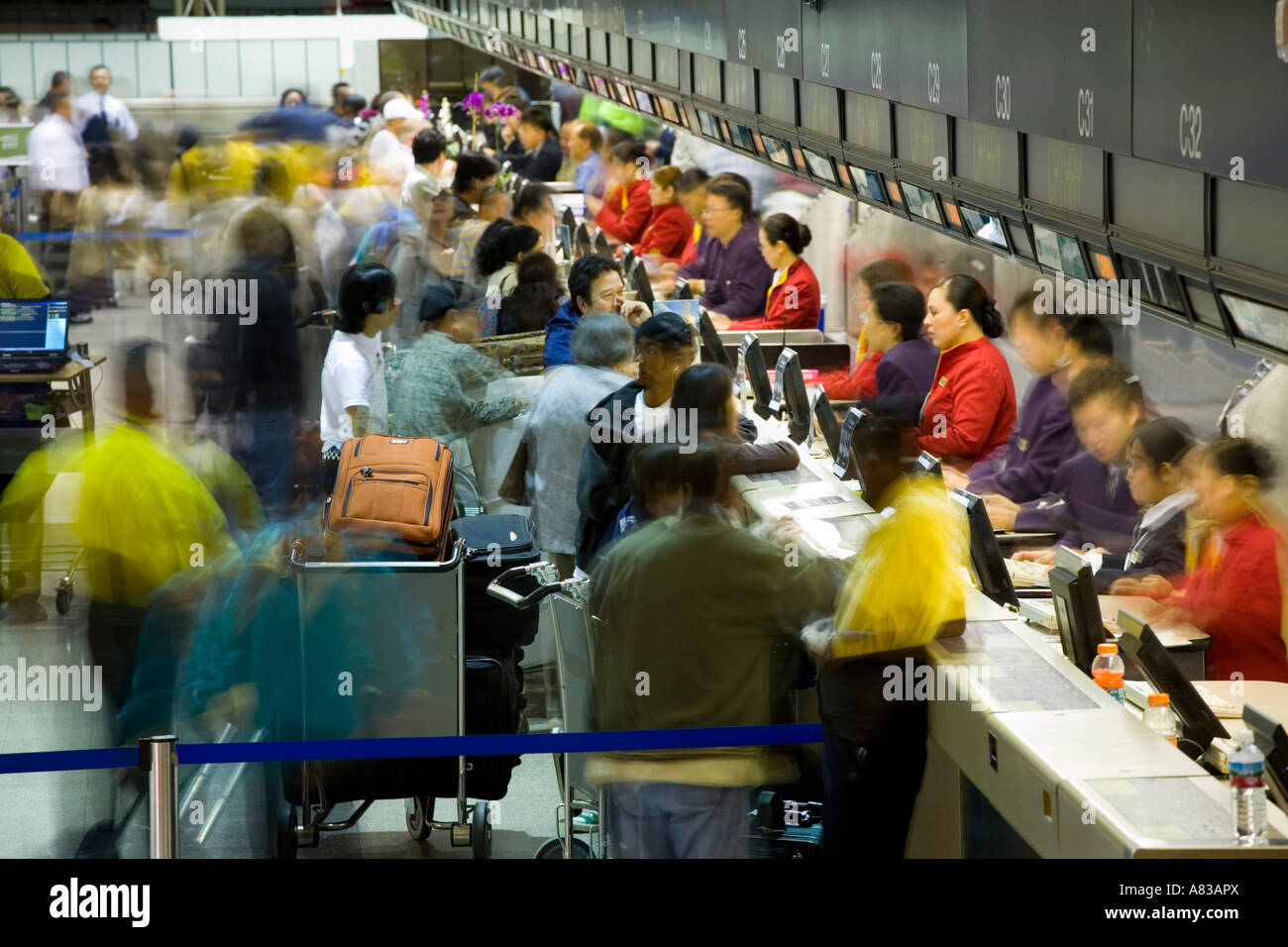 Travelers wait at the ticketing counter in the Tom Bradley ...