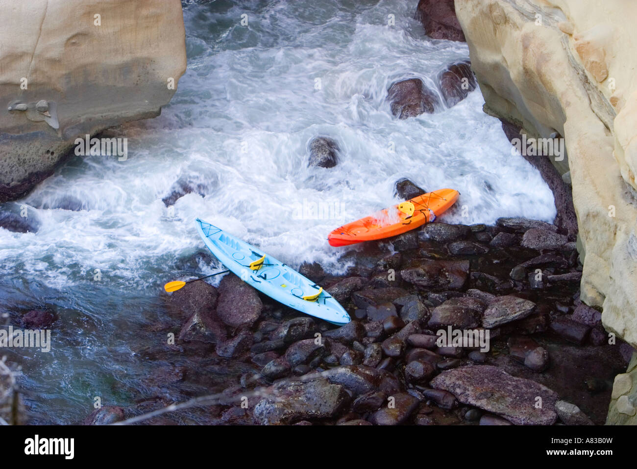Two kayaks abandoned and floating in ocean waves Stock Photo - Alamy