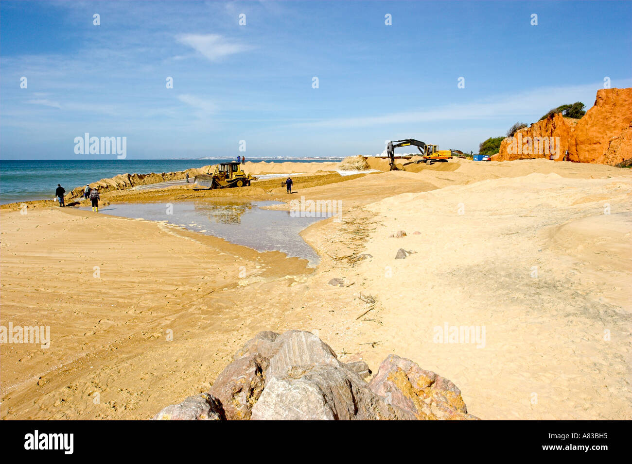 Refurbishment of a beach front with fresh sand to replace sand which ...