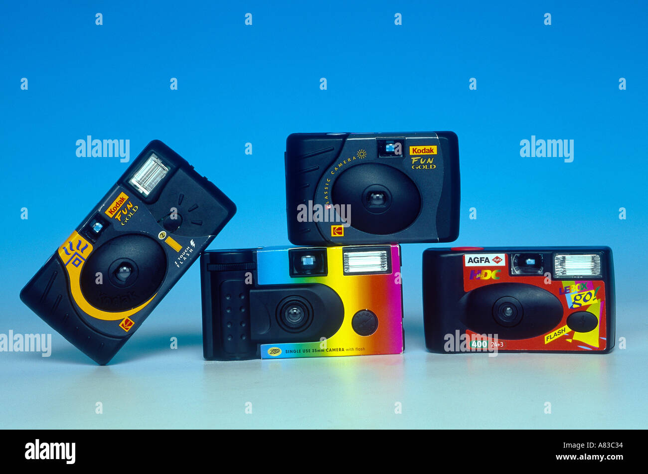 Pile of four disposable cameras on blue white background Stock Photo ...