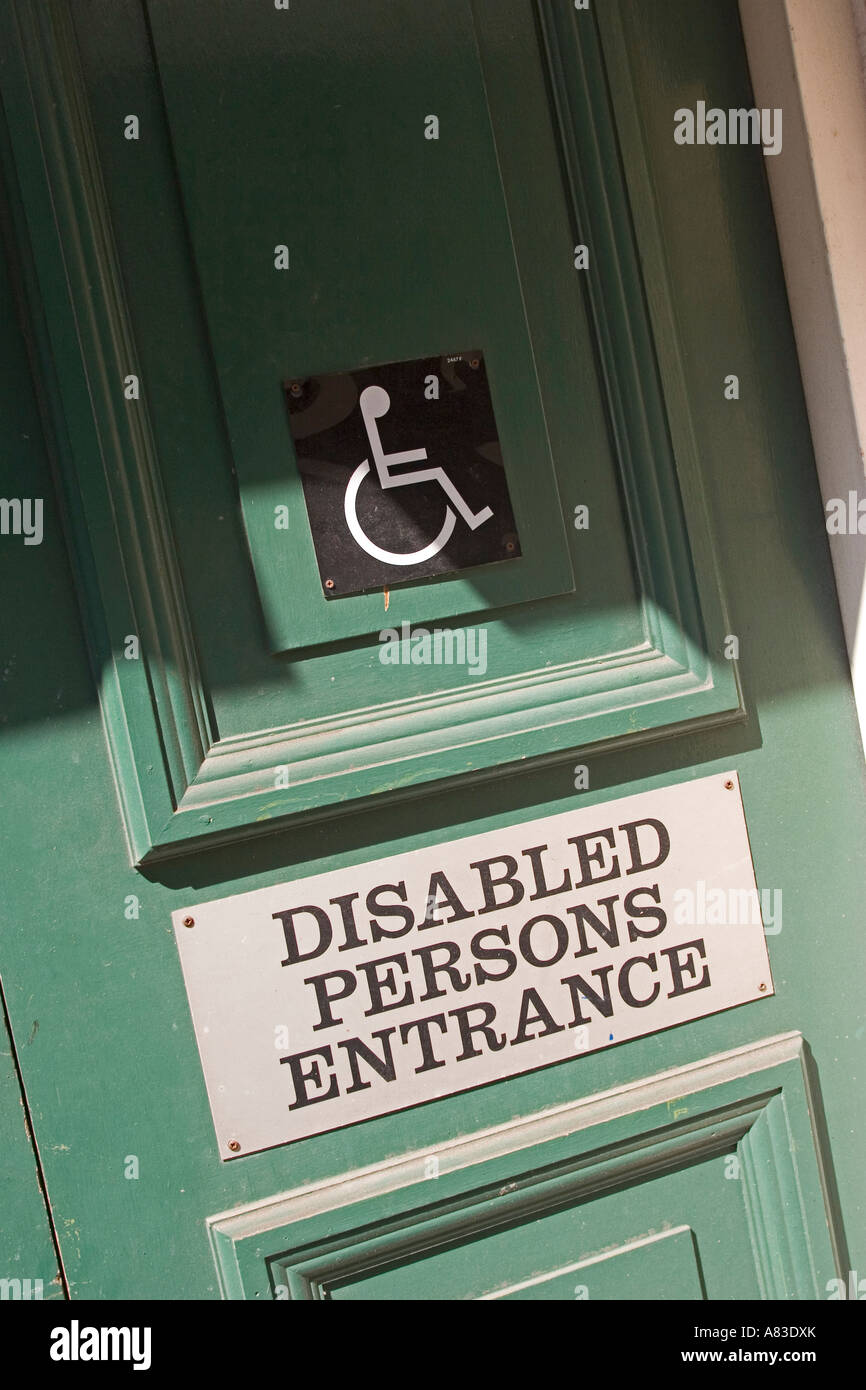 Disabled Persons Entrance and sign on green door Stock Photo - Alamy