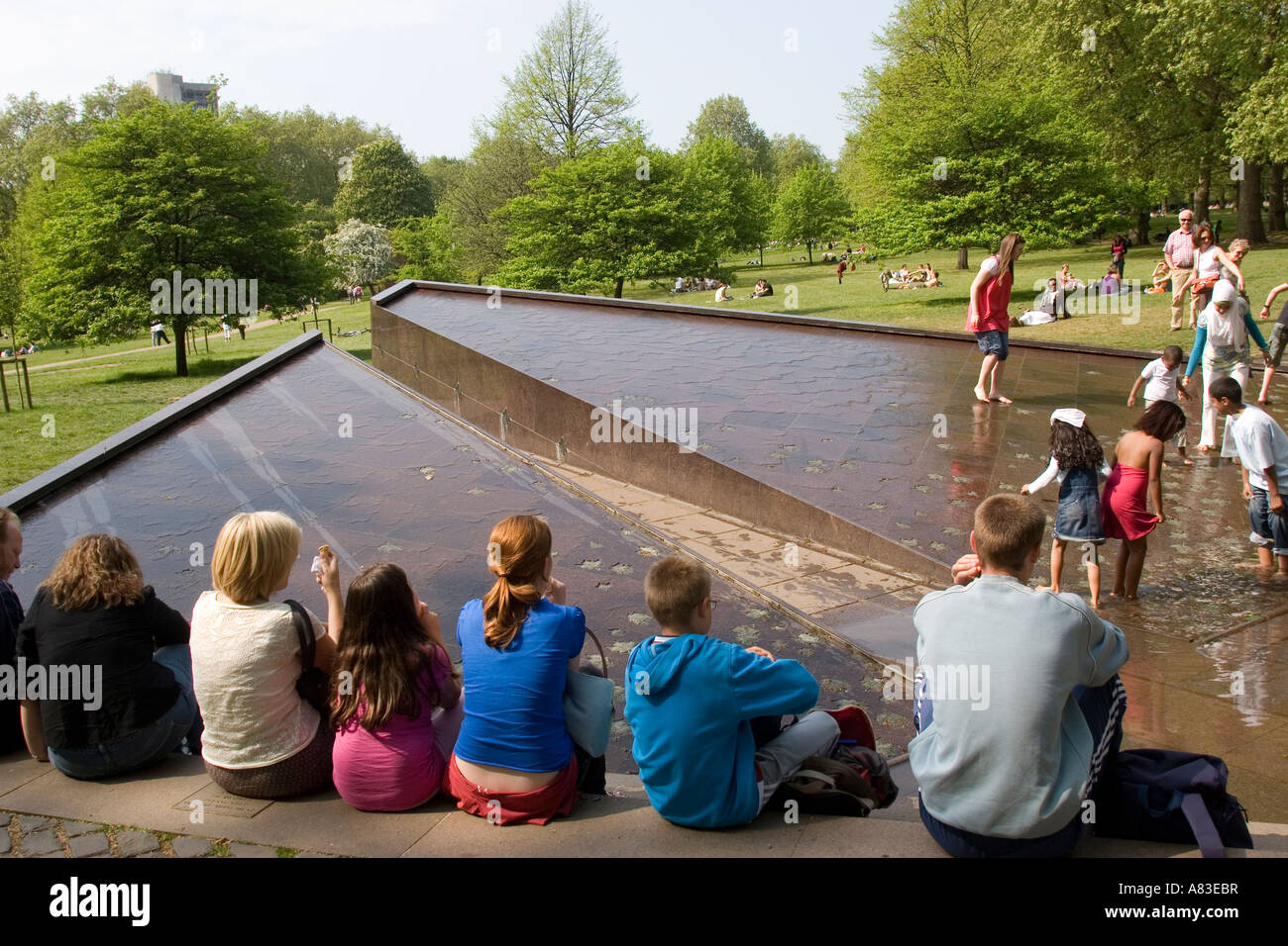 Tourists with children paddling in water feature at Canadian War ...