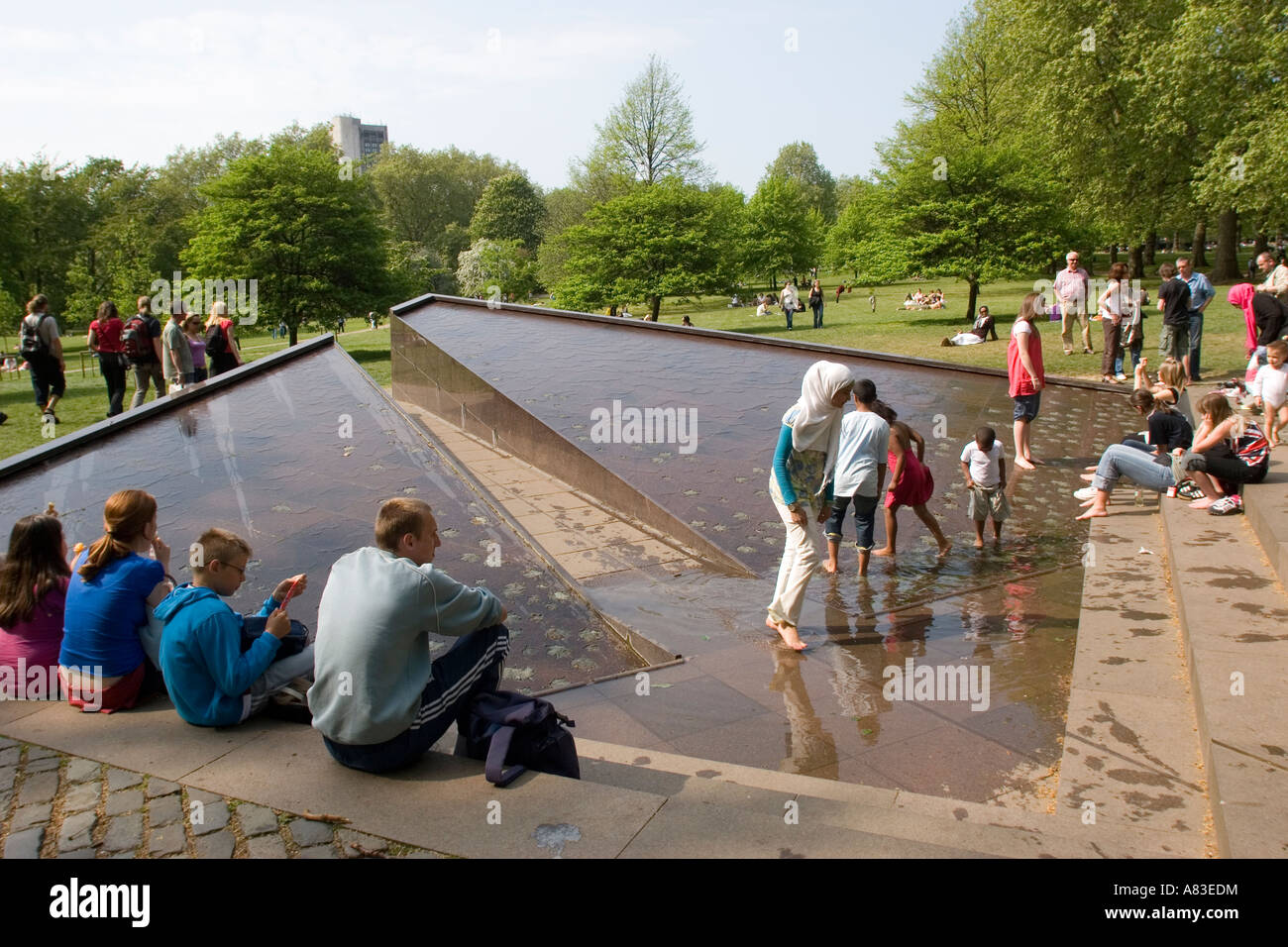 Tourists with children paddling in water feature at Canadian War ...