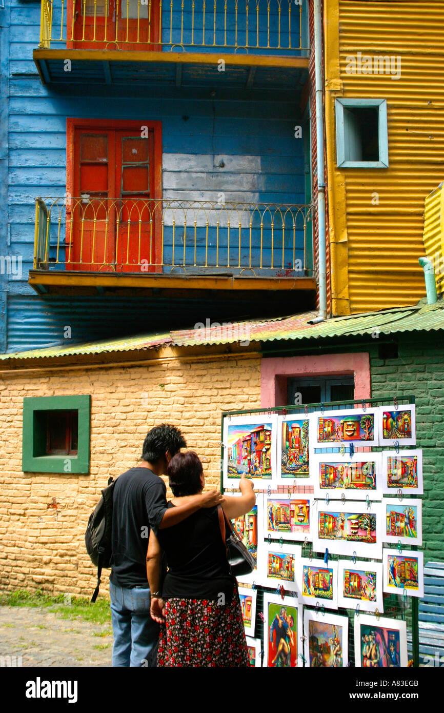 visitors choosing paintings by local artists displayed in an openair ...