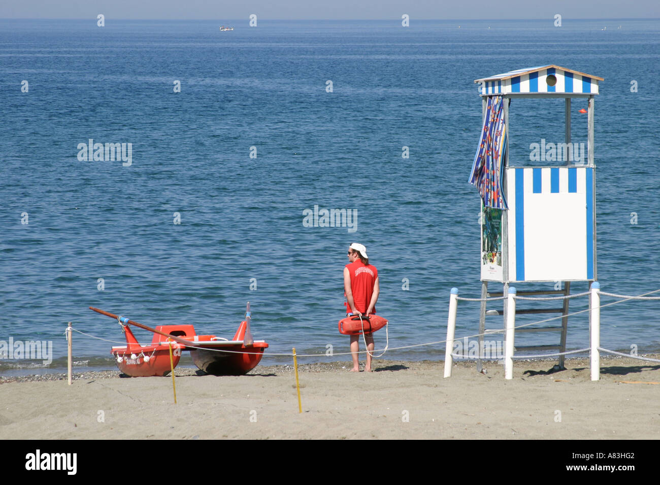 Beach watcher at work holding life preserver on the beach of Levanto on ...