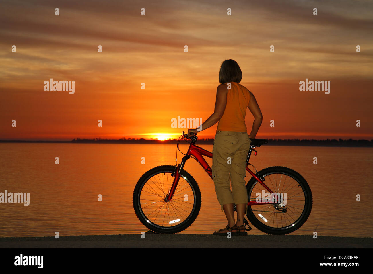 A visitor with her bike at sunset along San Diego Bay Chula Vista ...