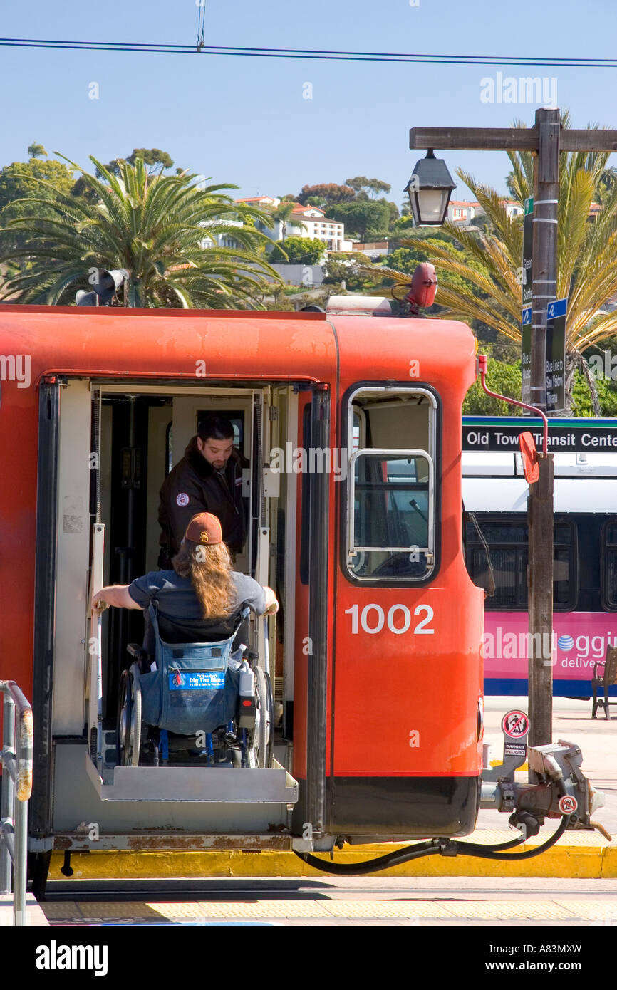 Handicapped passenger boards a Trolley using a lift in San Diego ...