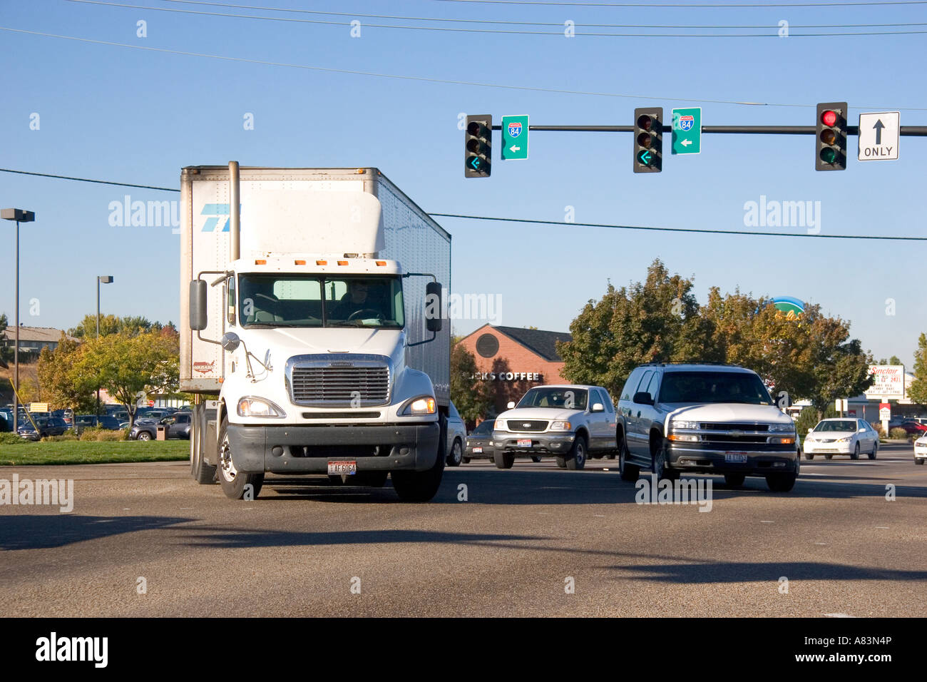 A delivery truck in traffic making a left turn at an intersection in ...