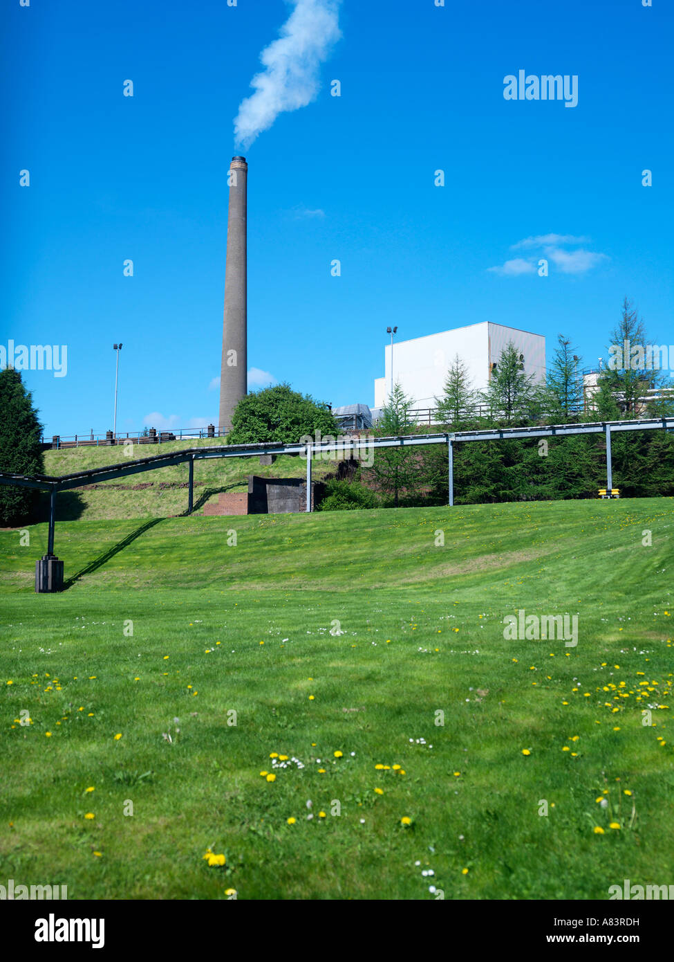chimney with steam in landscape Stock Photo - Alamy