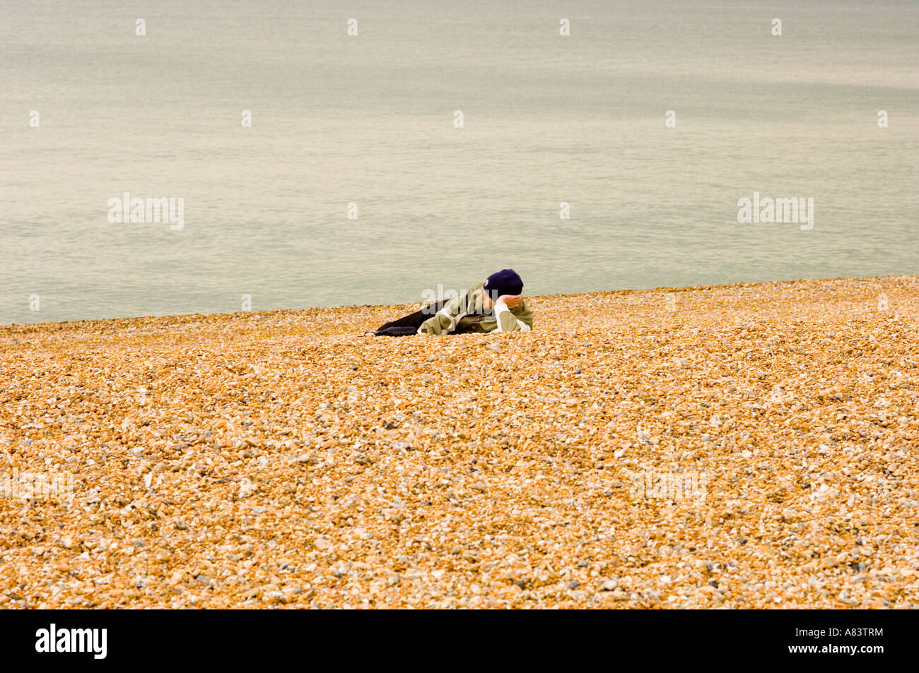 Man lying on beach Stock Photo - Alamy
