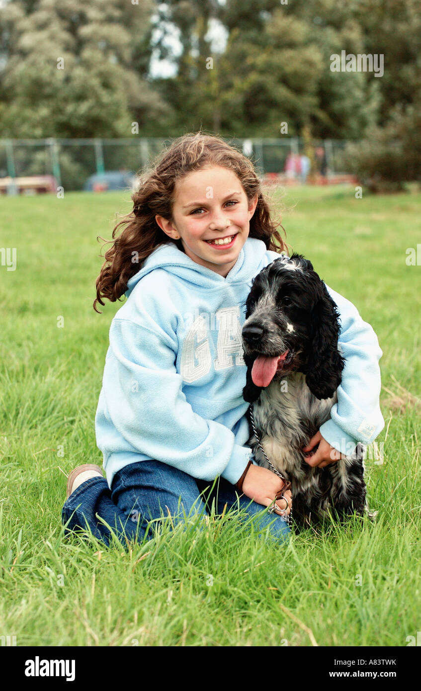 Girl with cocker spaniel dog sitting on grass Stock Photo - Alamy