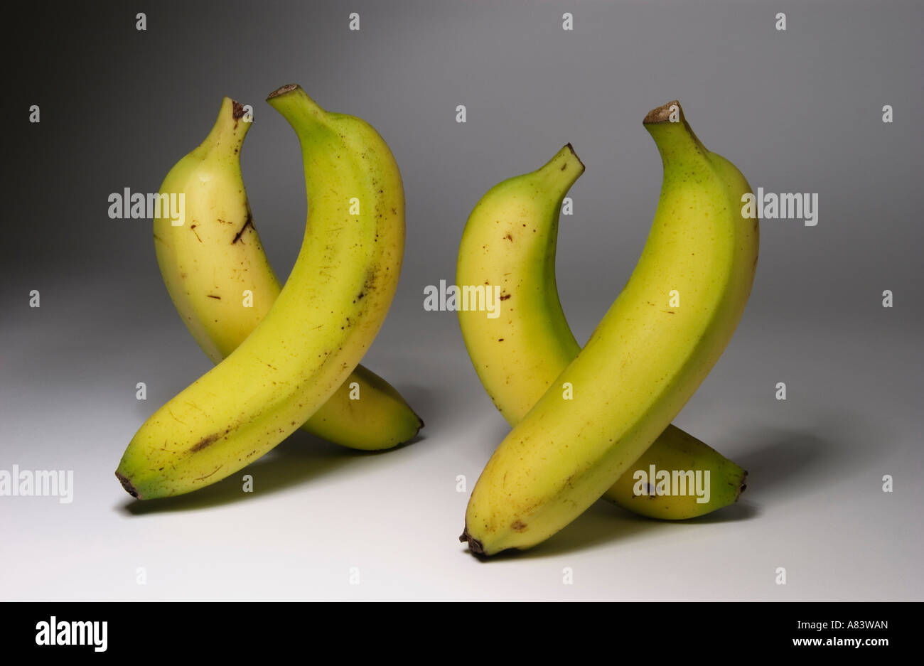 Four bananas on white background Stock Photo - Alamy