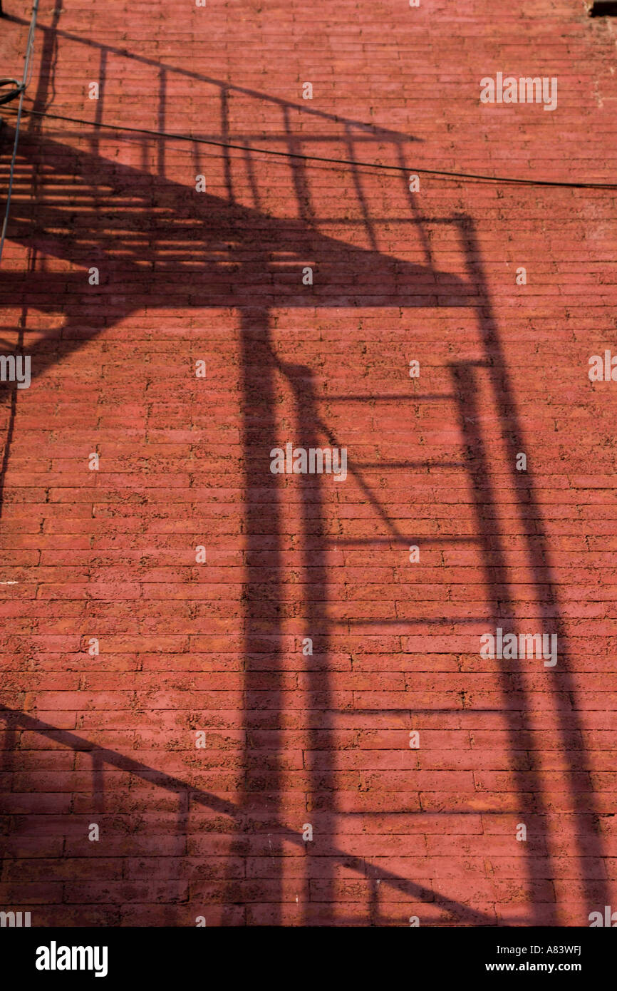 New York City fire escape ladder shadow on brick wall Stock Photo - Alamy