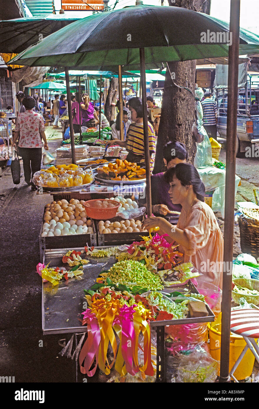 Thai fruits, vegetables and flower garlands on pavement stalls, fried ...