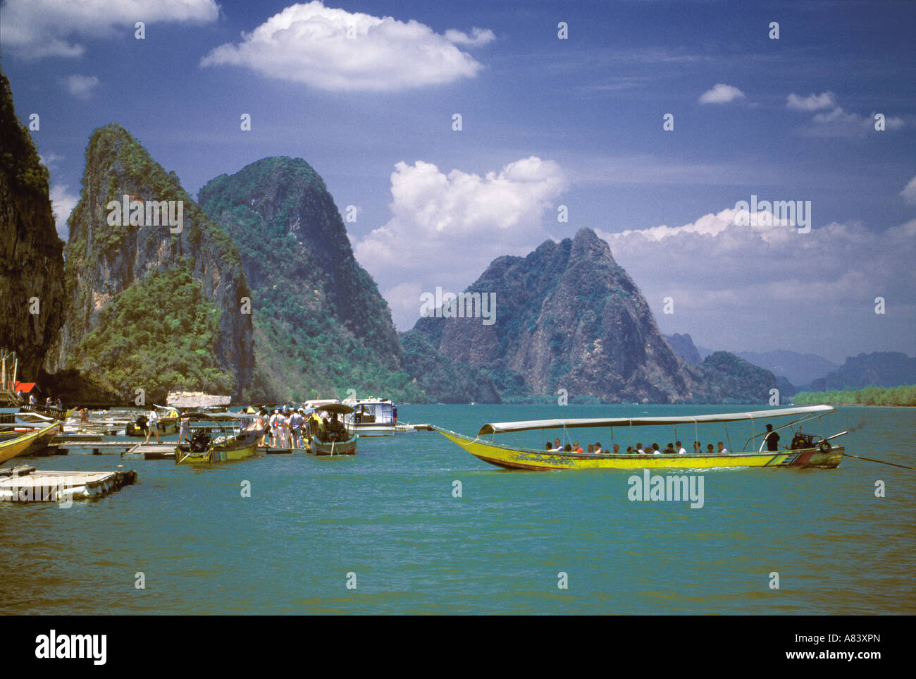 Tour boat approaches the muslim floating village of Ko Panyi which is ...
