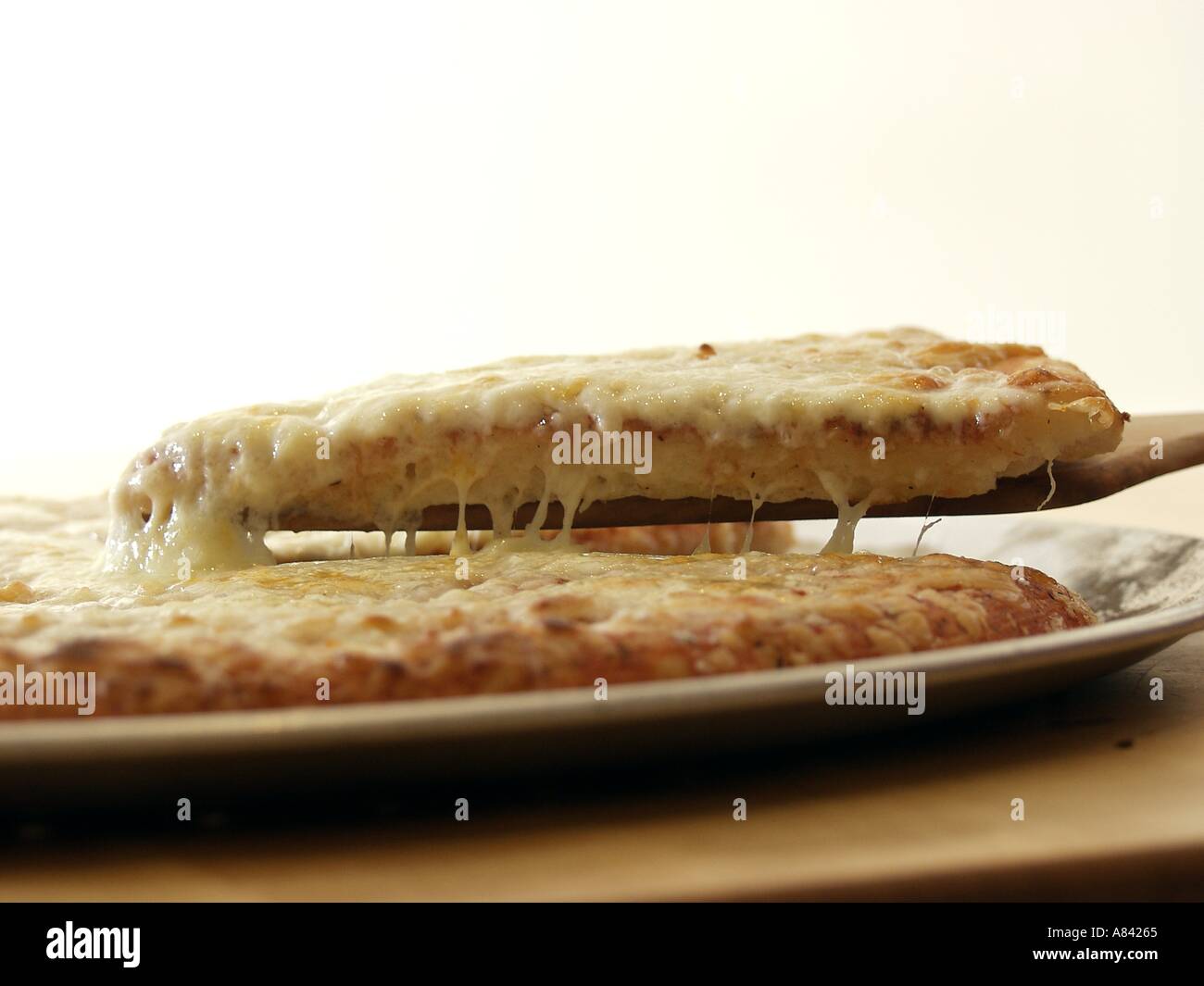 Lifting a Slice of Cheese Pizza Stock Photo - Alamy