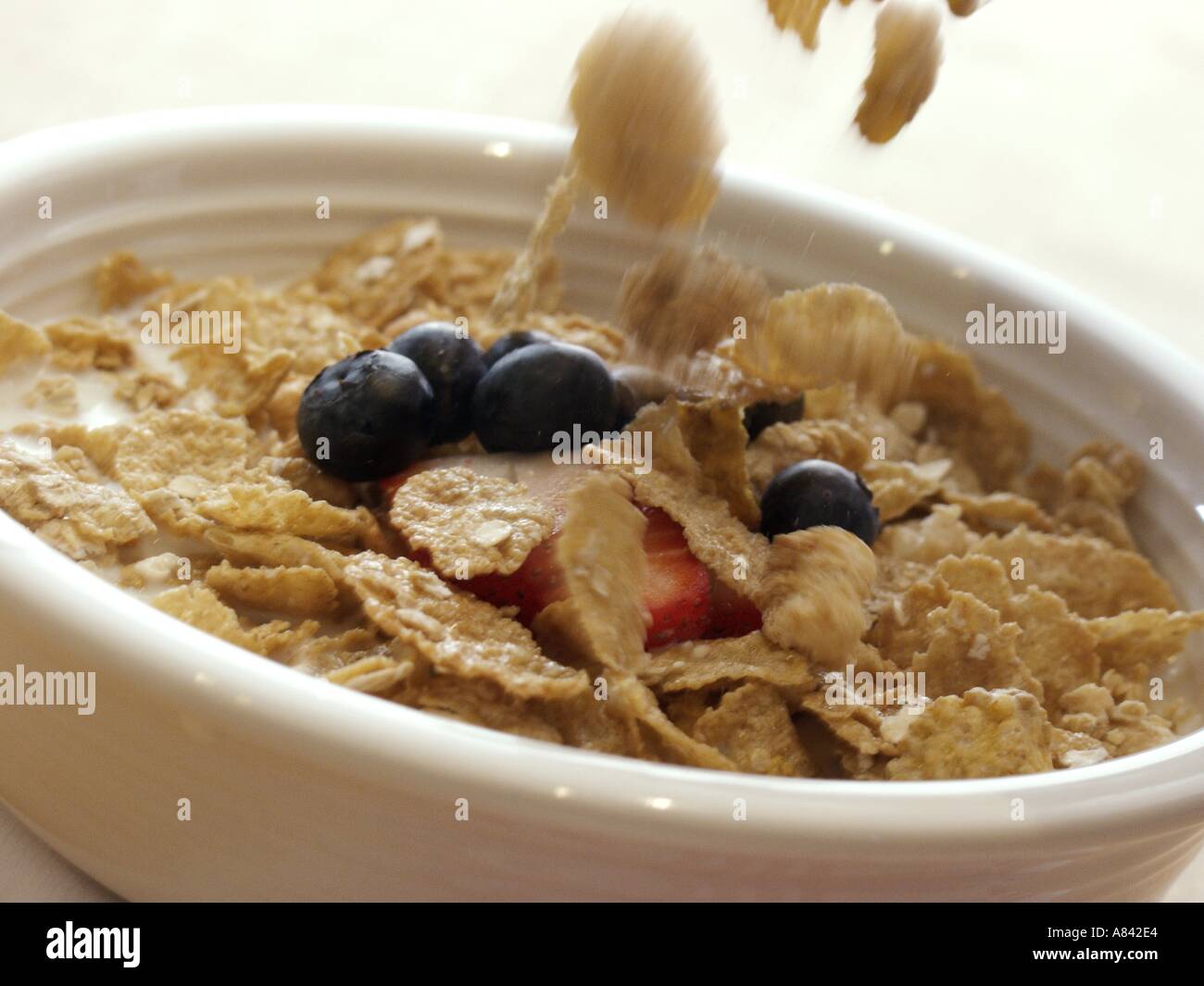 Cornflakes Falling into a Bowl Stock Photo - Alamy