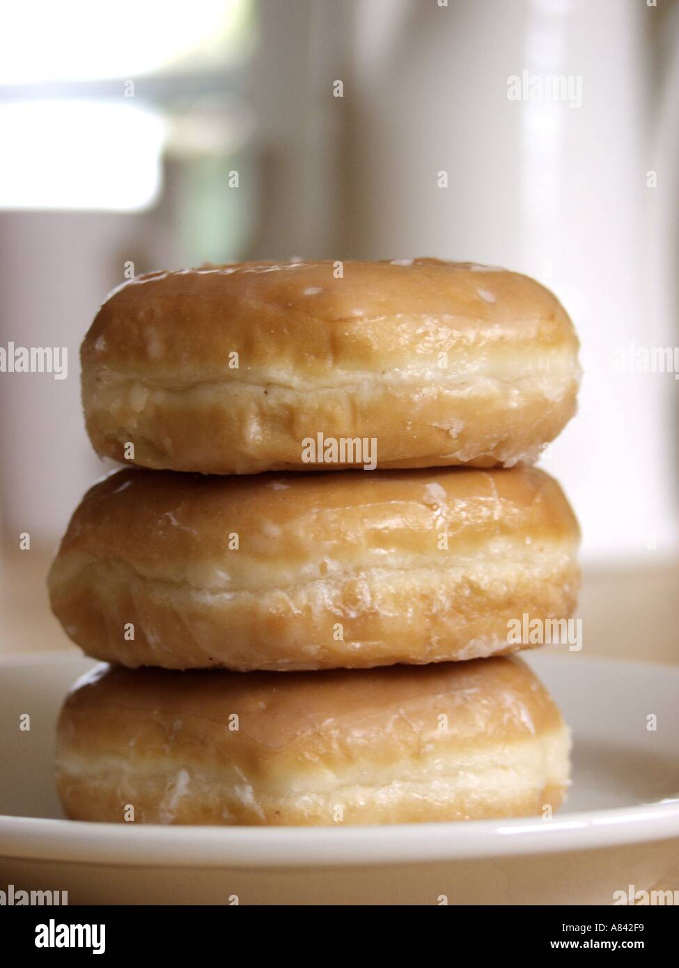 Three Glazed Donuts Stock Photo - Alamy