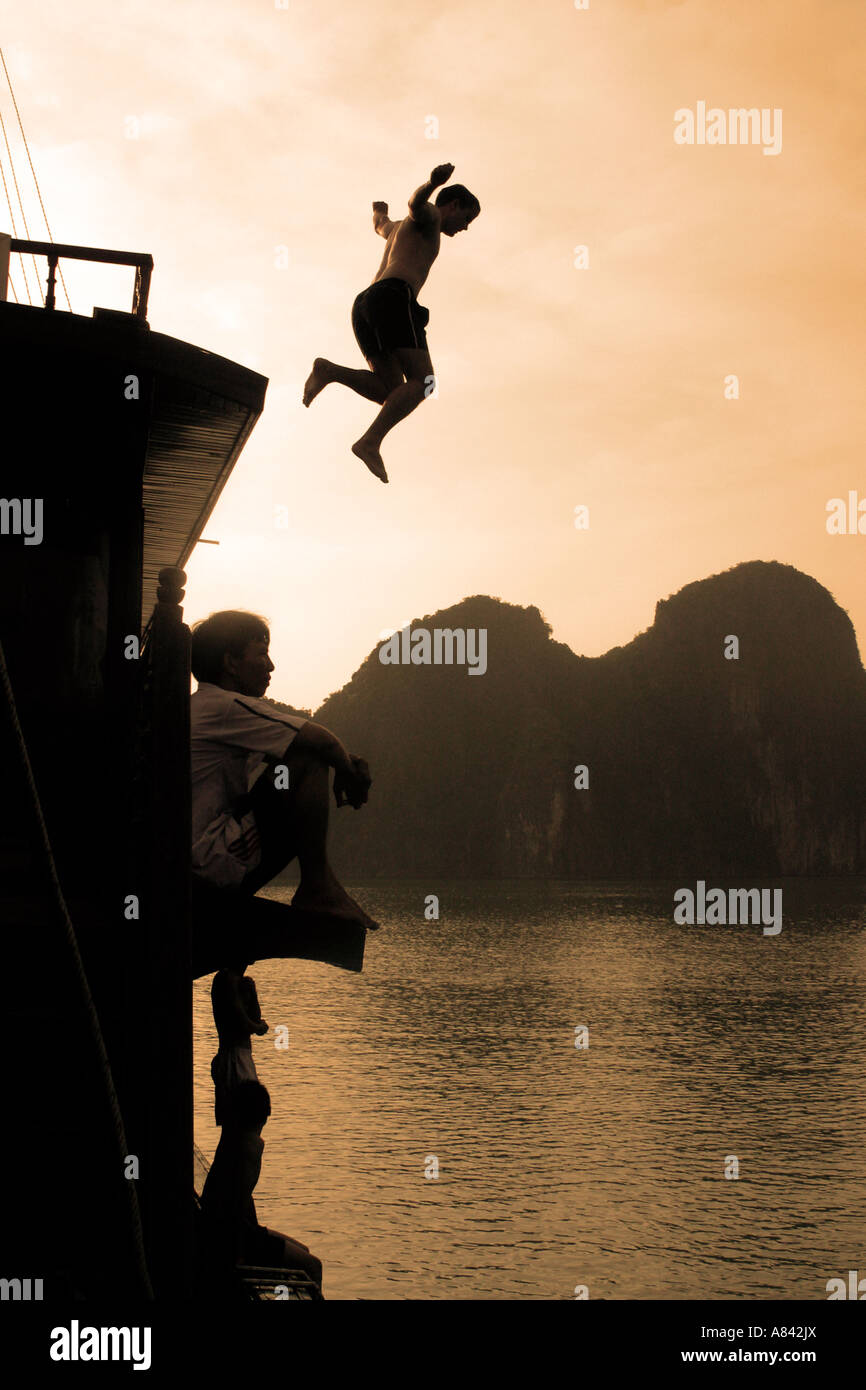 Silhouette of a Man jumping off a boat halong bay vietnam Stock Photo ...