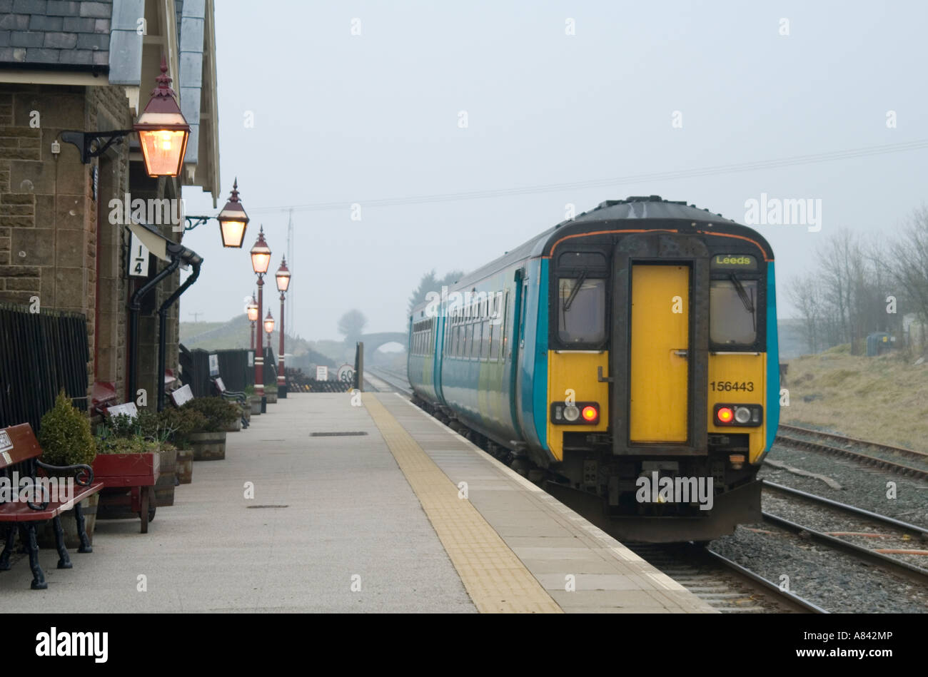 Train stopping at the pretty rural station of Ribblehead on the Settle ...