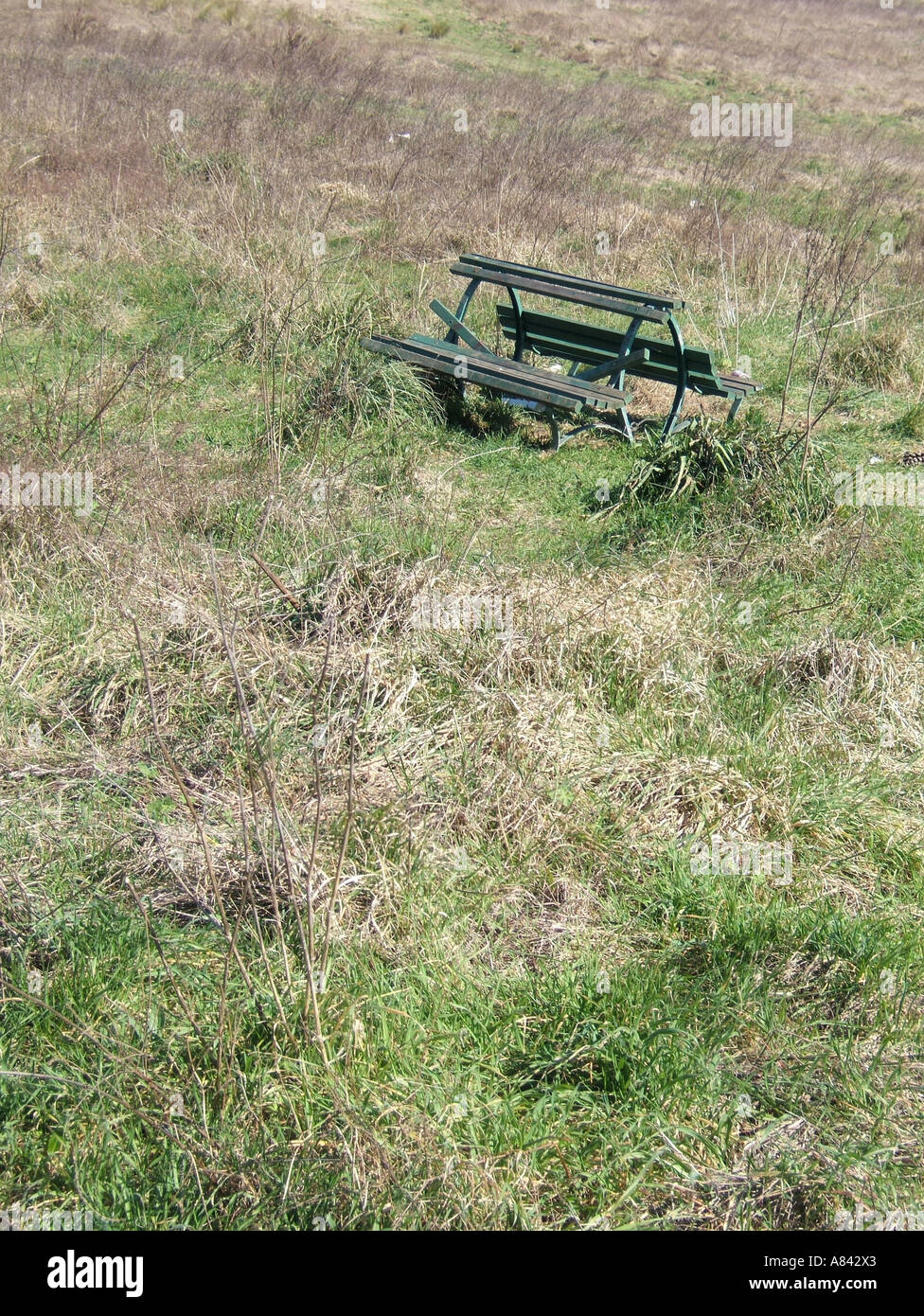two damaged benches in field Stock Photo - Alamy