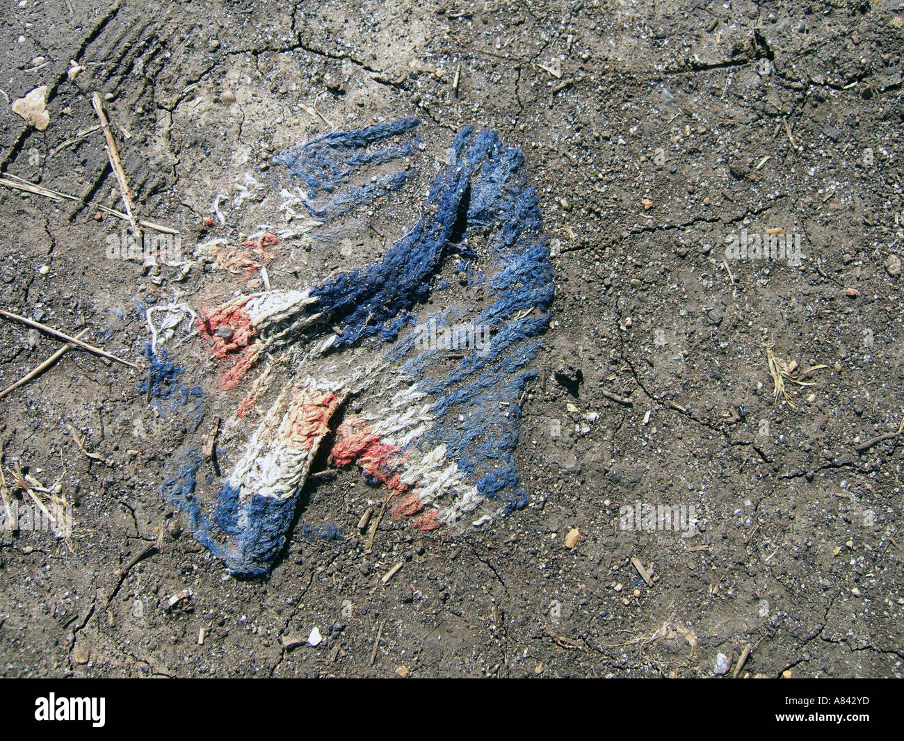 one dirty cap buried in earth Stock Photo - Alamy