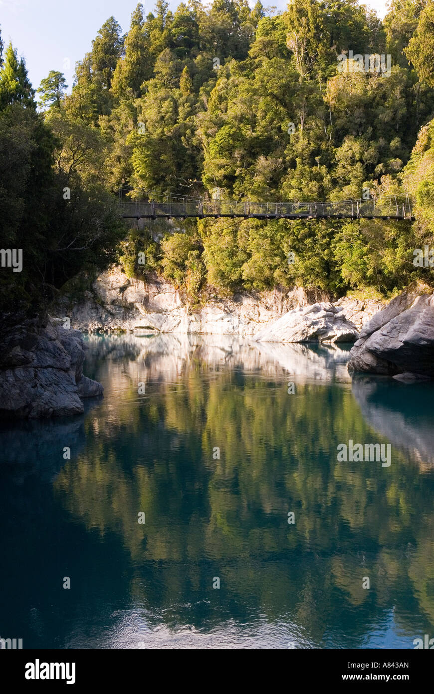 Swing bridge over the blue waters of the Hokitika Gorge West Coast of ...
