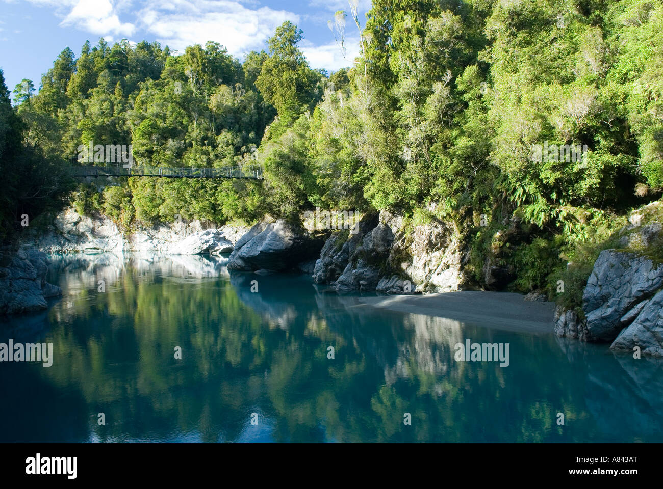 Swing bridge over the blue waters of the Hokitika Gorge West Coast of ...