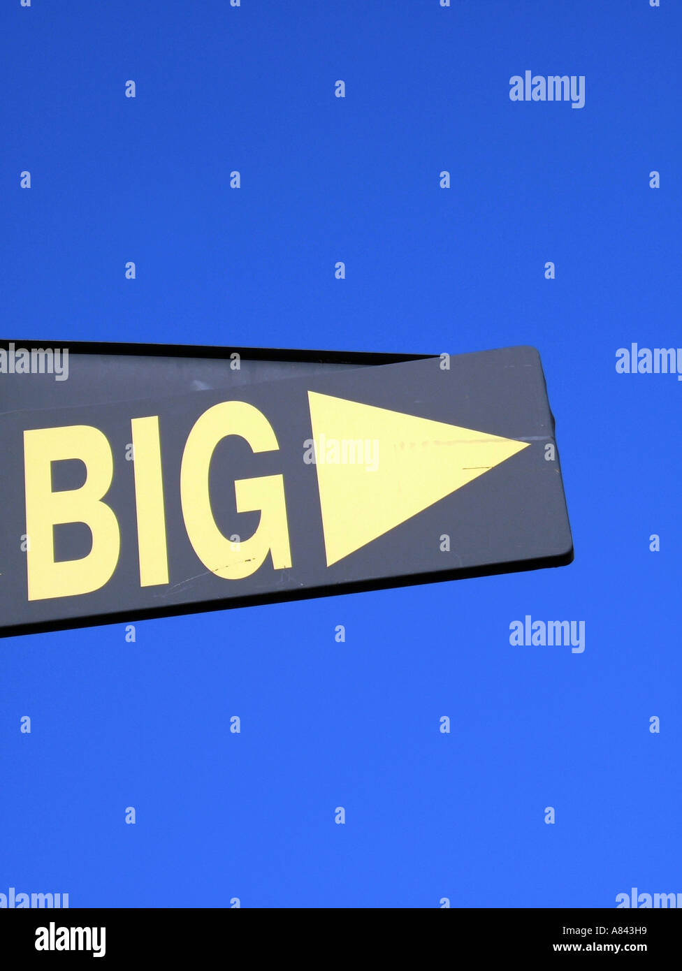 big and arrow sign with blue sky Stock Photo - Alamy