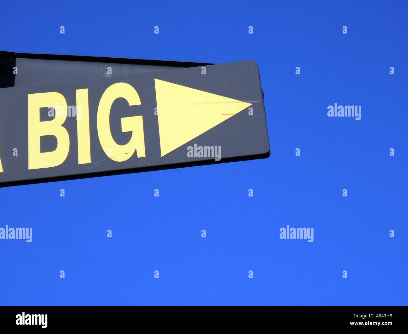 big and arrow sign with blue sky Stock Photo - Alamy