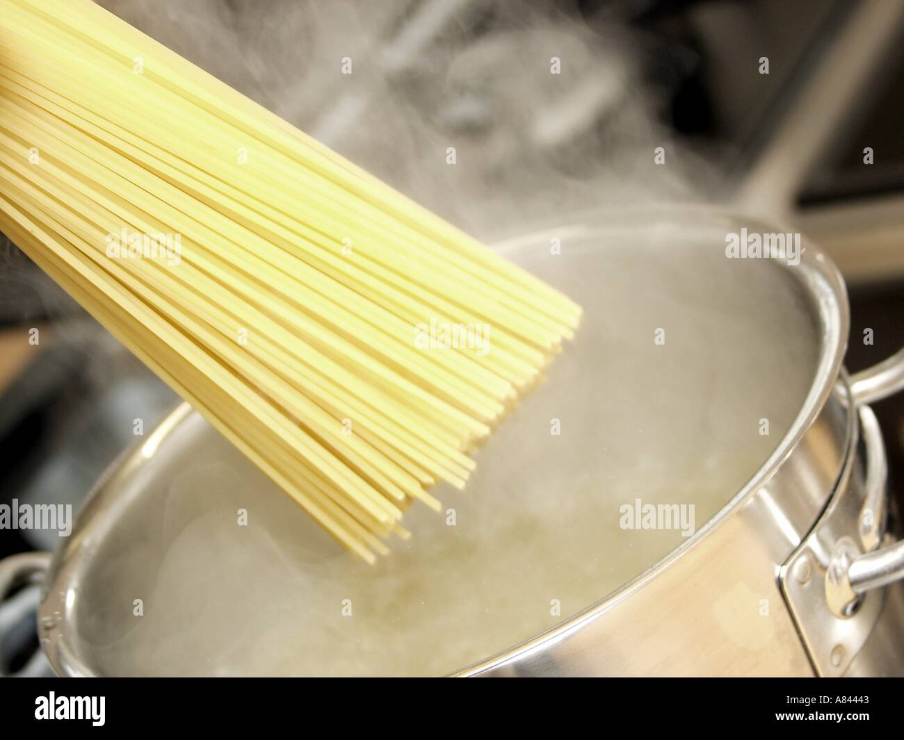 Spaghetti Going into a Pot of Boiling Water Stock Photo - Alamy
