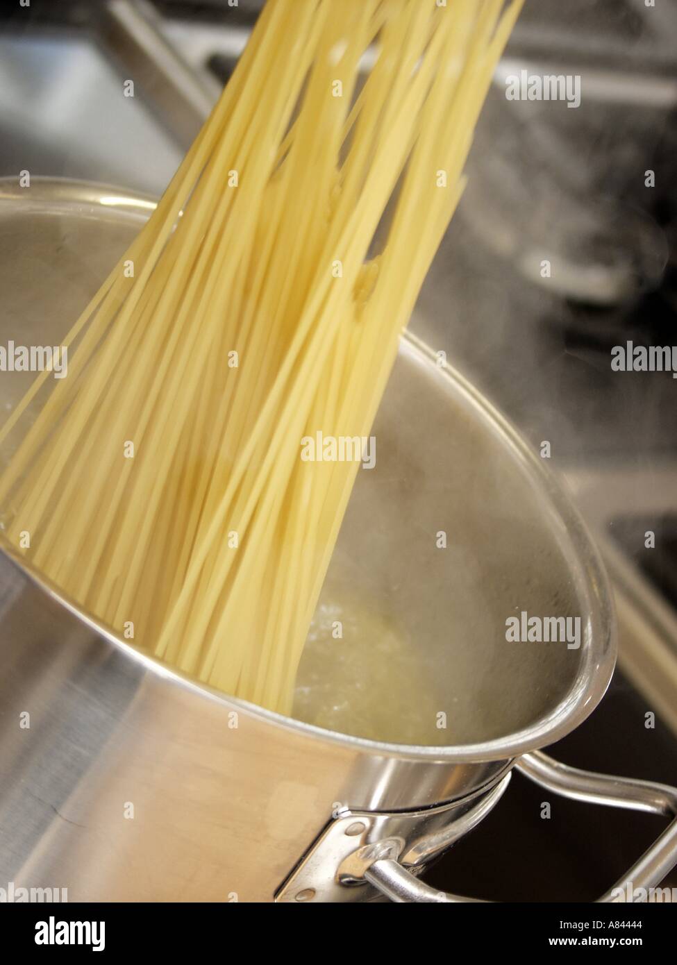 Spaghetti Going into a Pot of Boiling Water Stock Photo - Alamy