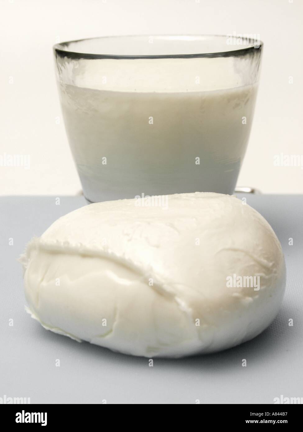 Two Balls of Mozzarella Cheese with a Glass of MIlk Stock Photo - Alamy