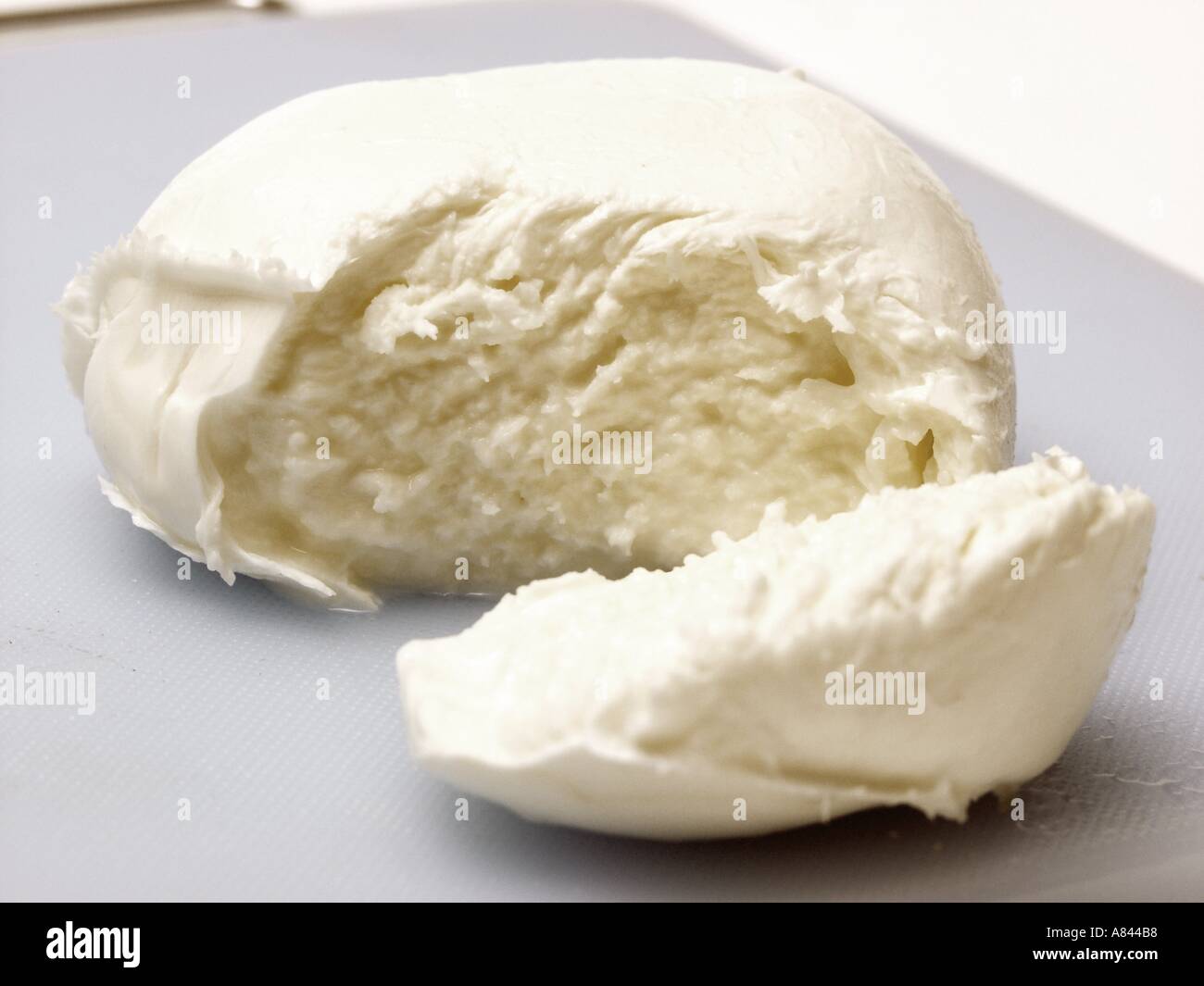 A Ball of Mozzarella with a Piece Broken off Stock Photo - Alamy