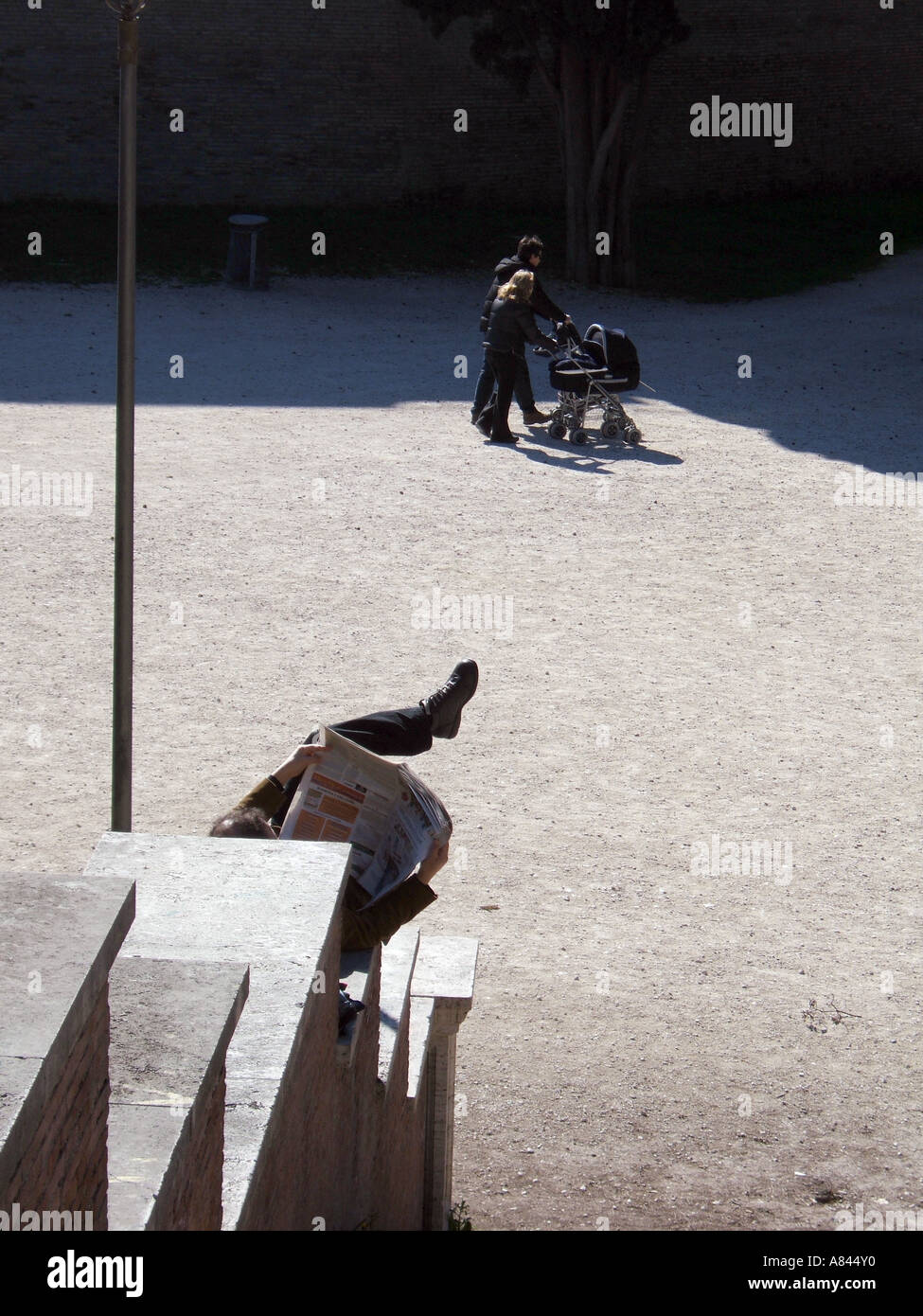 man reading paper in rome Stock Photo - Alamy