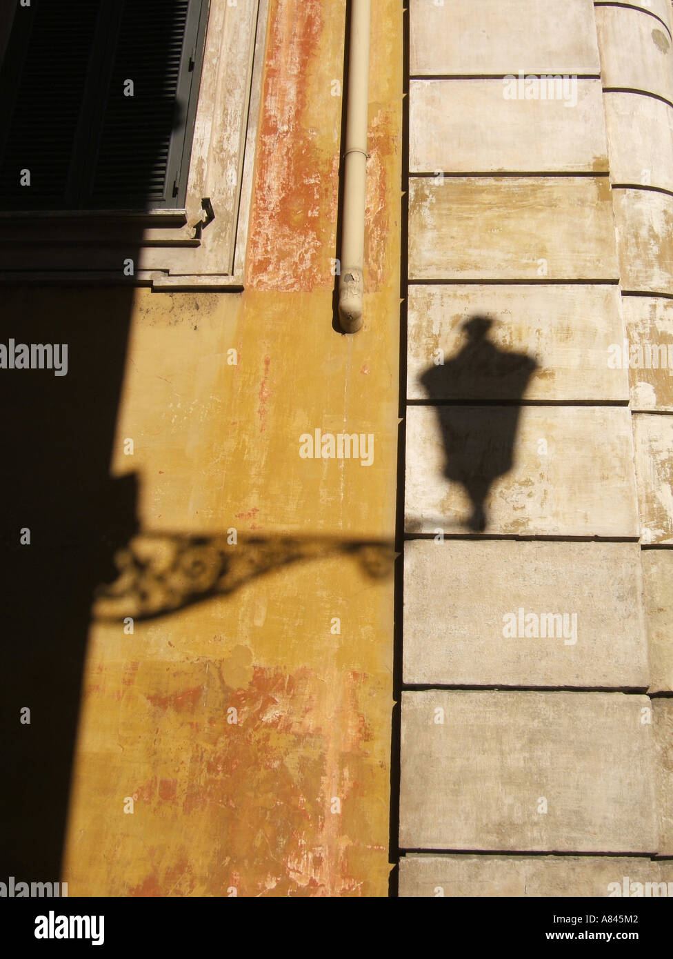 lamp post shadow on wall in rome Stock Photo - Alamy