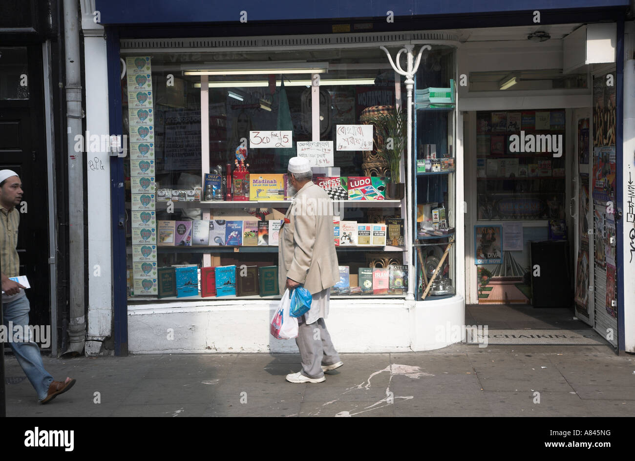 Muslim man looking at shop window display, Brick Lane, East End, London ...