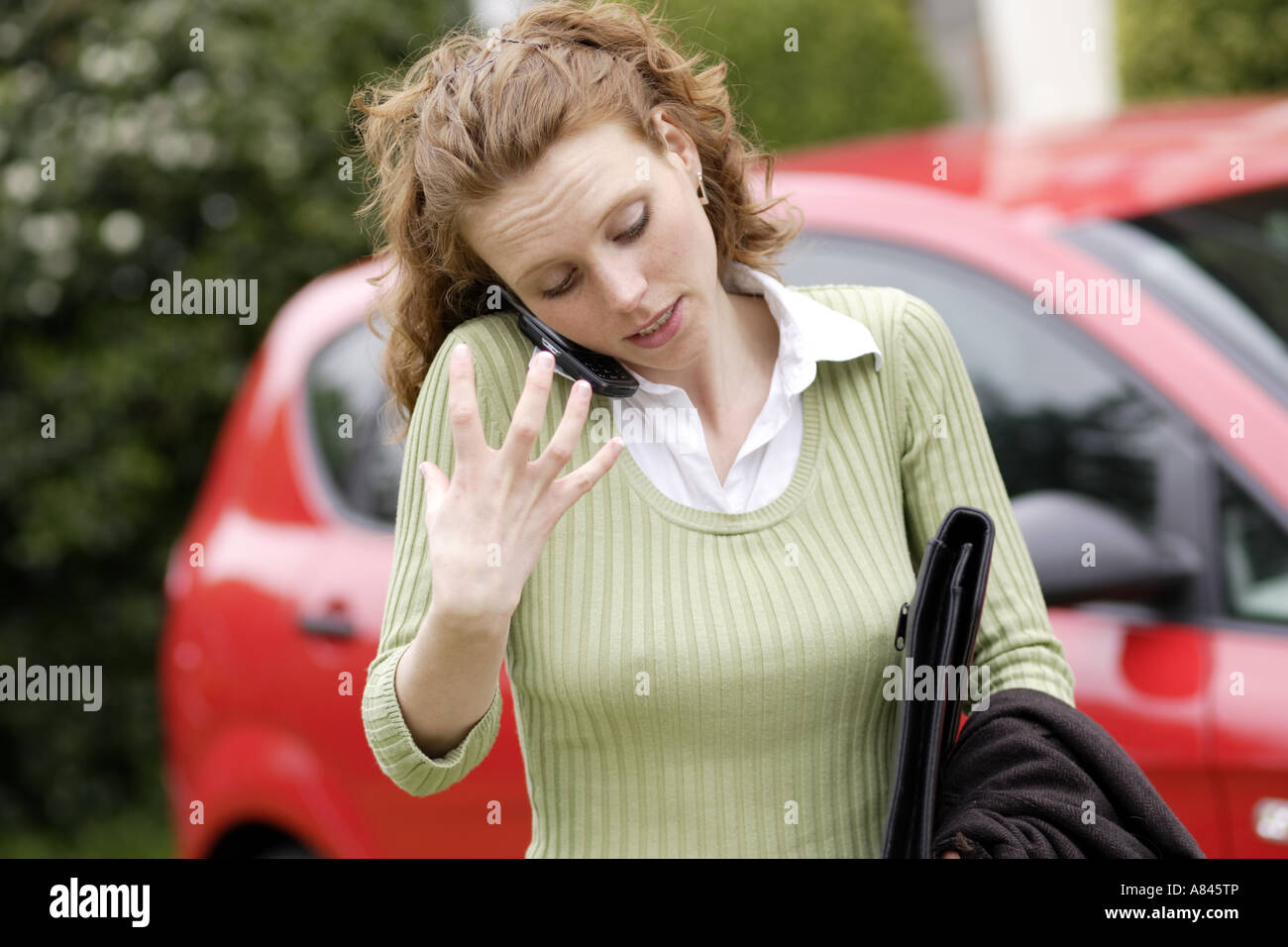 Stressed woman talking on phone Stock Photo - Alamy
