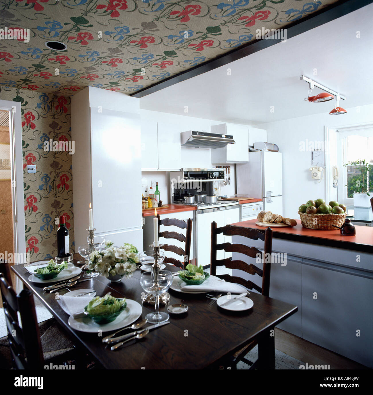 Place settings on wooden dining table in large kitchen diningroom ...