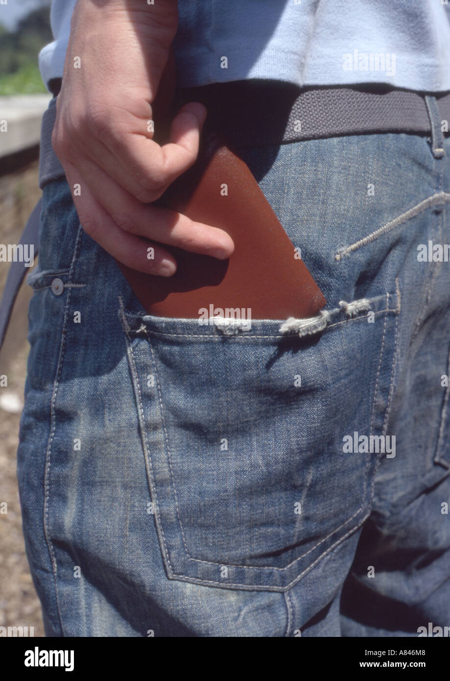 young man pulling out wallet from pocket Stock Photo - Alamy