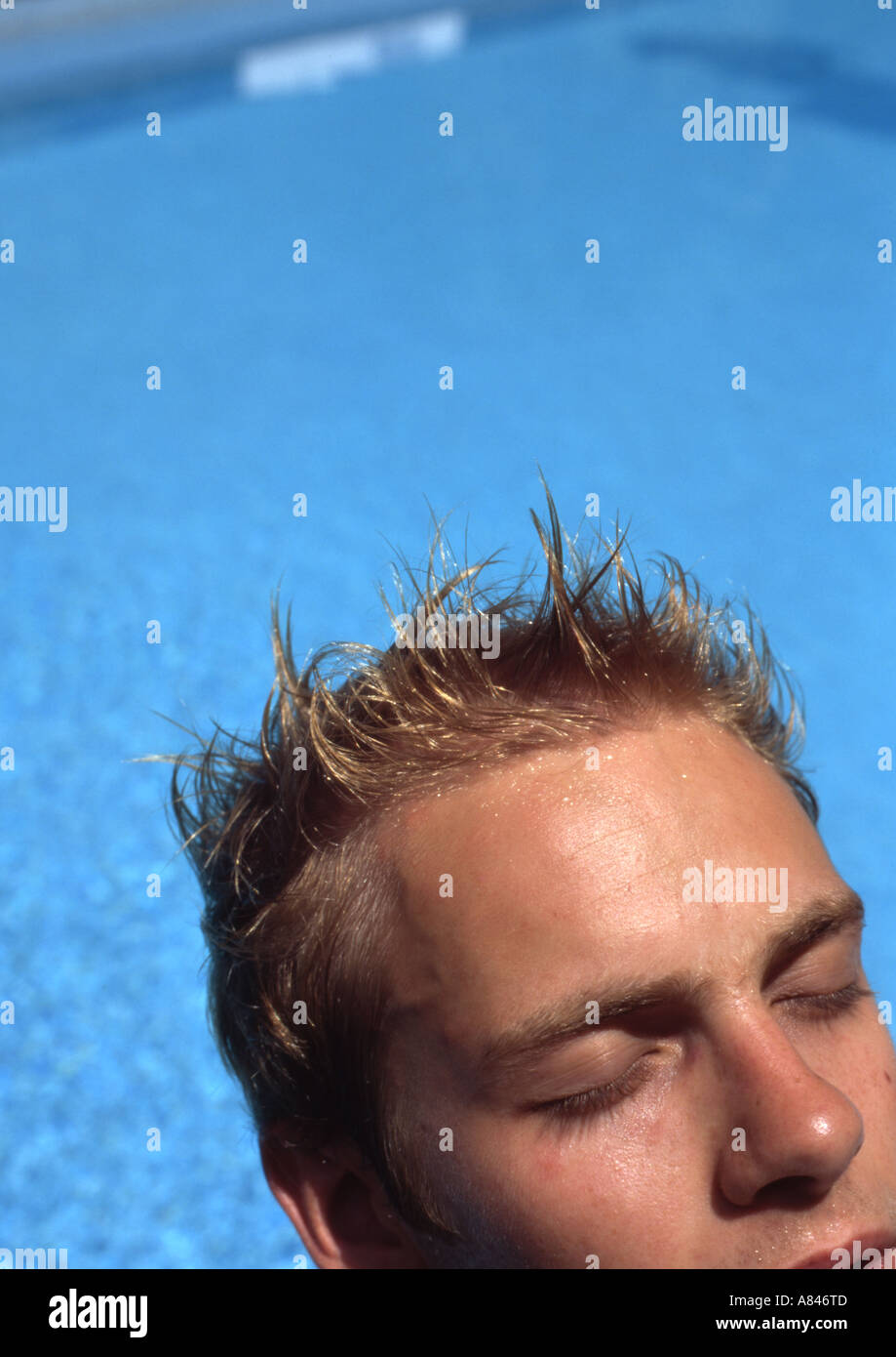 man sleeping by swimming pool Stock Photo - Alamy